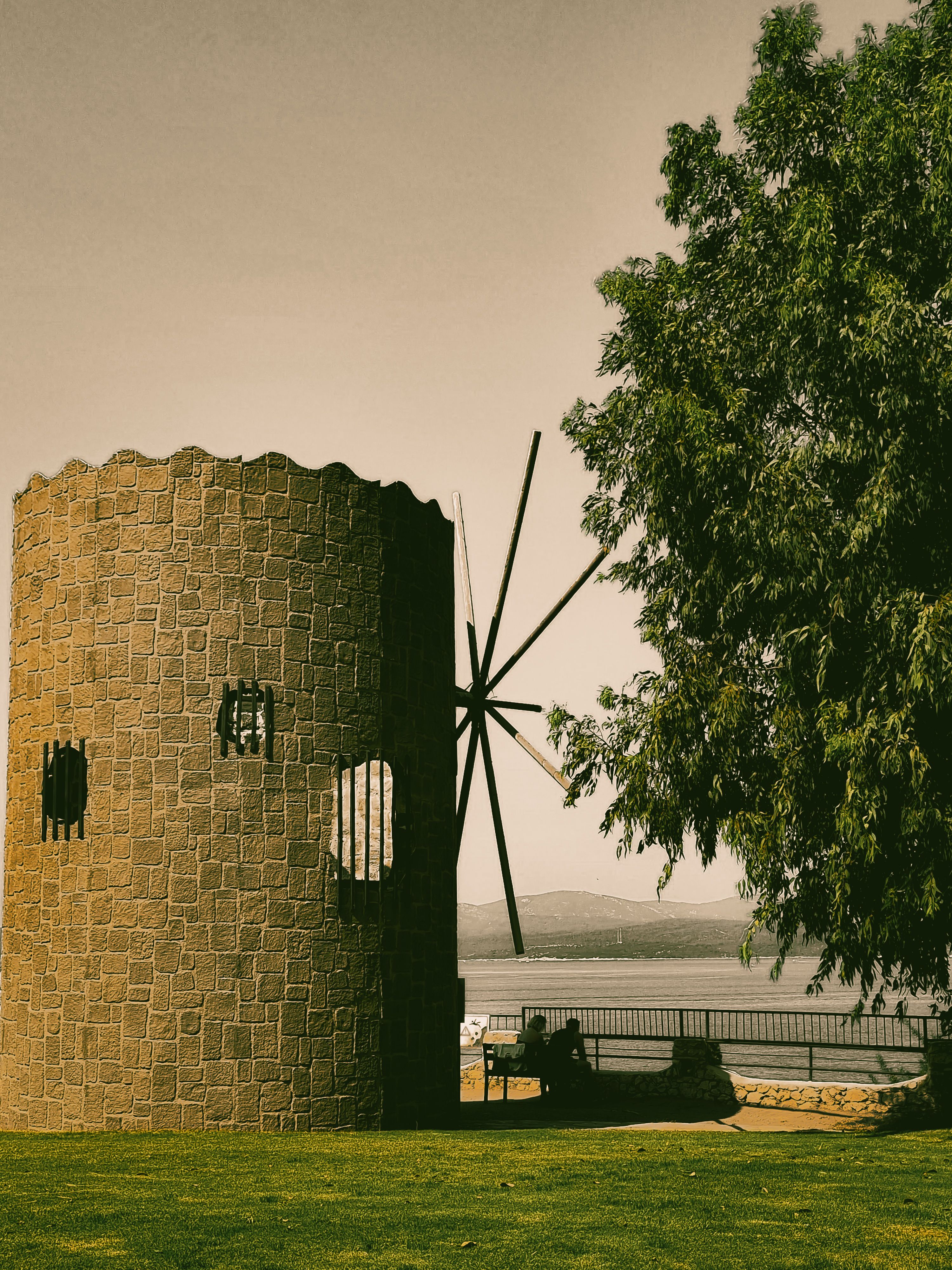 View of a Vintage Windmill near a Body of Water · Free Stock Photo