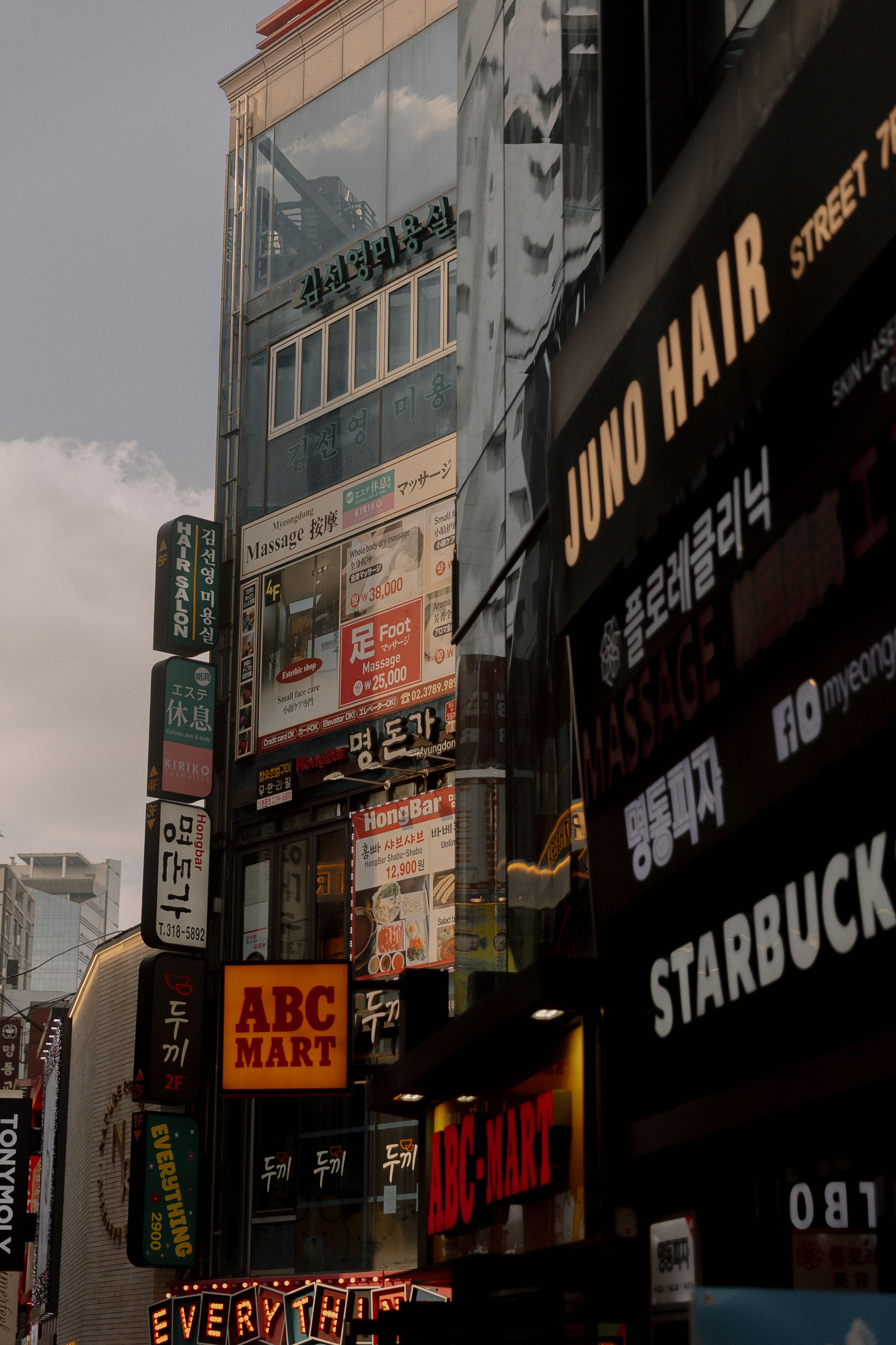 A city street with many signs and buildings · Free Stock Photo