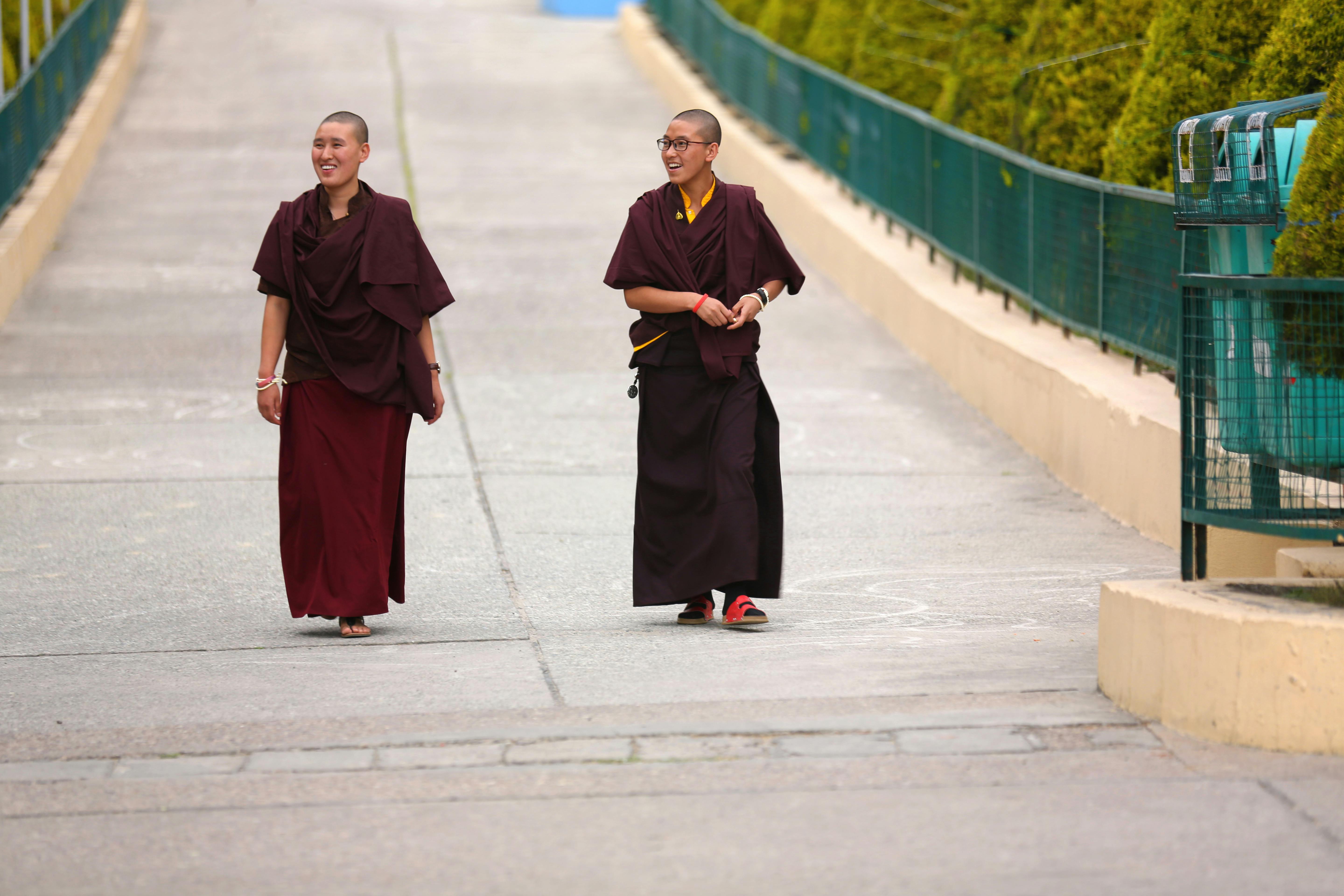 Photo of Two Monks Walking on Street · Free Stock Photo