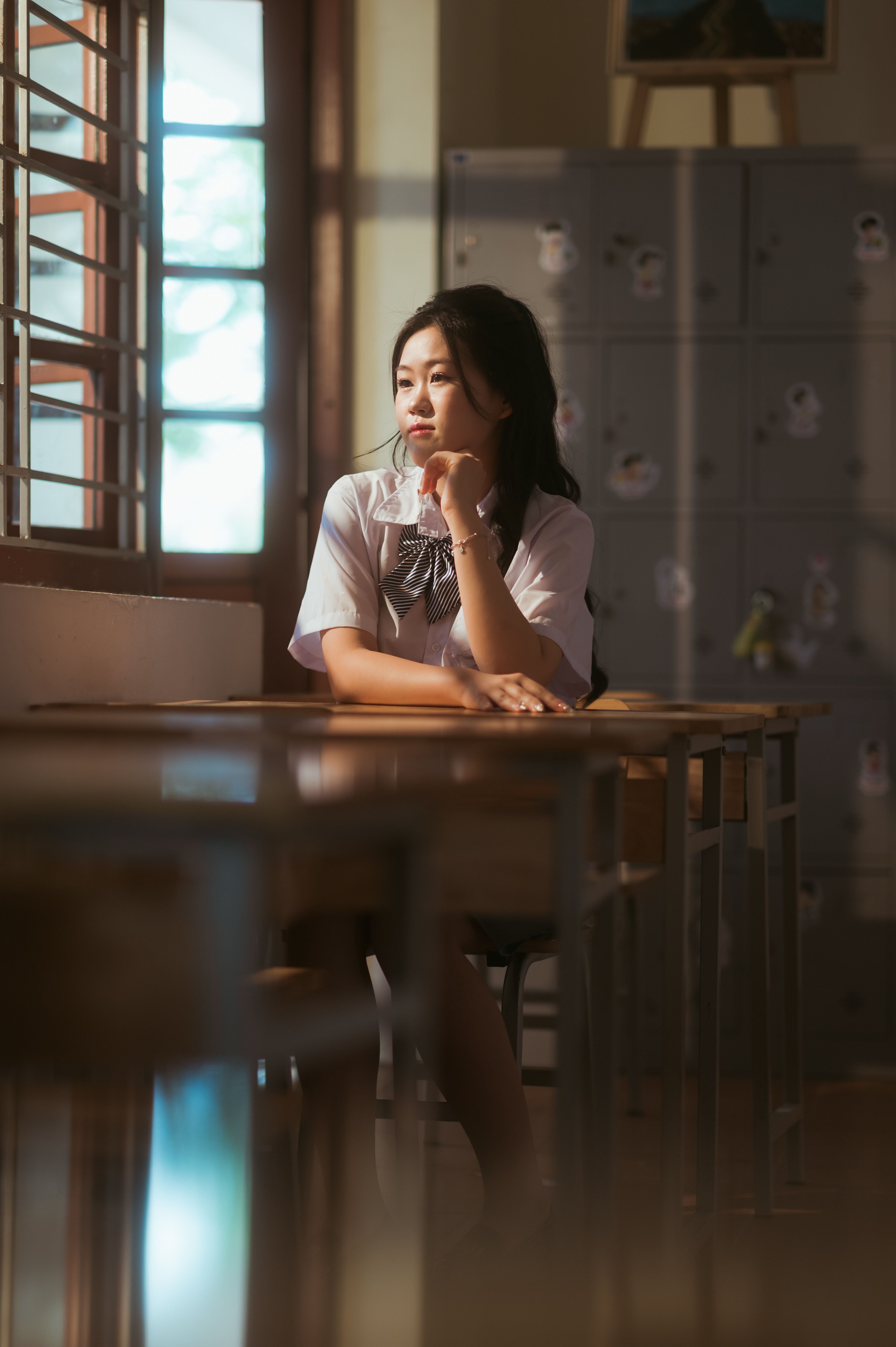 Brunette Student in White Shirt Sitting Alone in Classroom · Free Stock ...