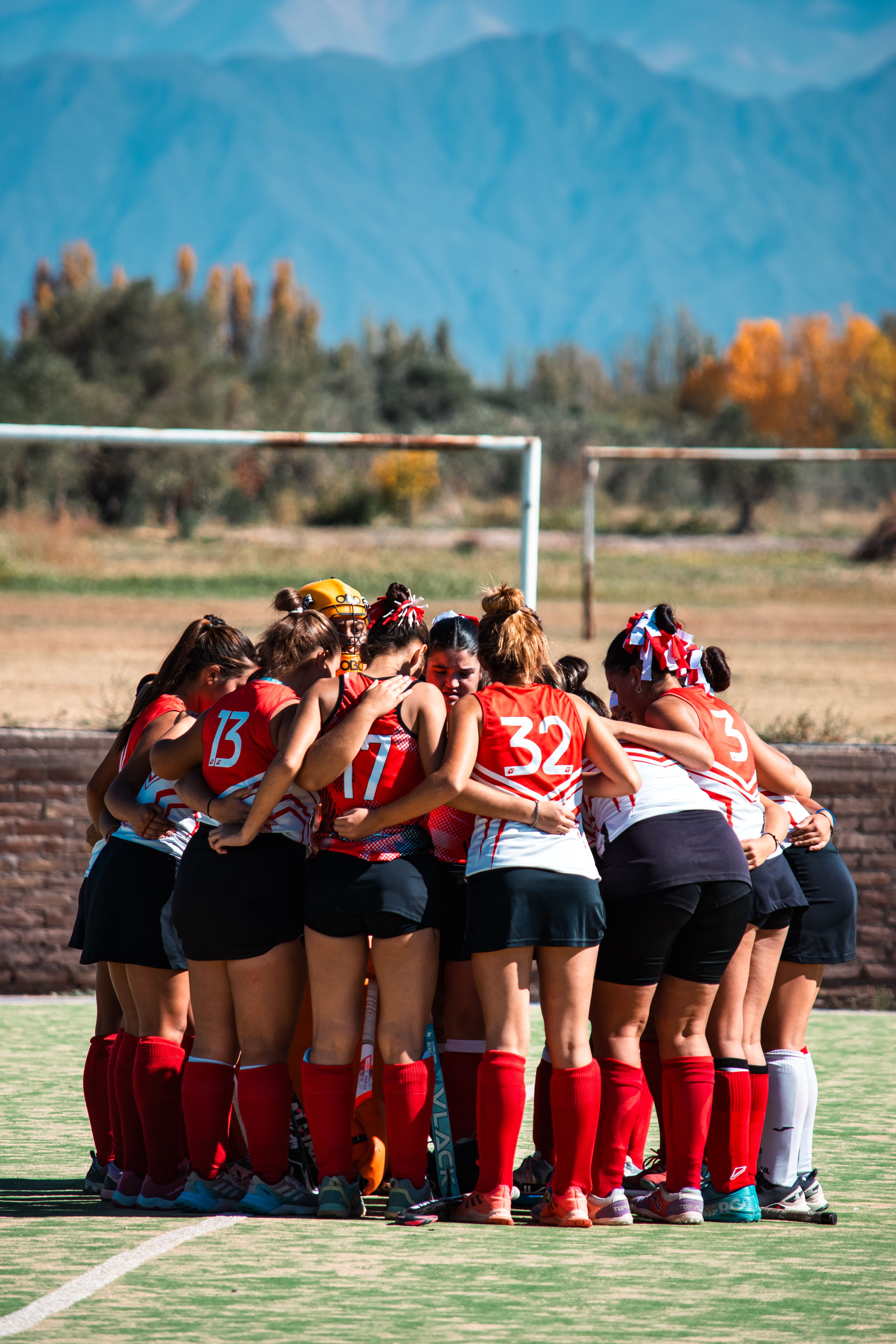 A Female Hockey Team Standing Together on a Field · Free Stock Photo