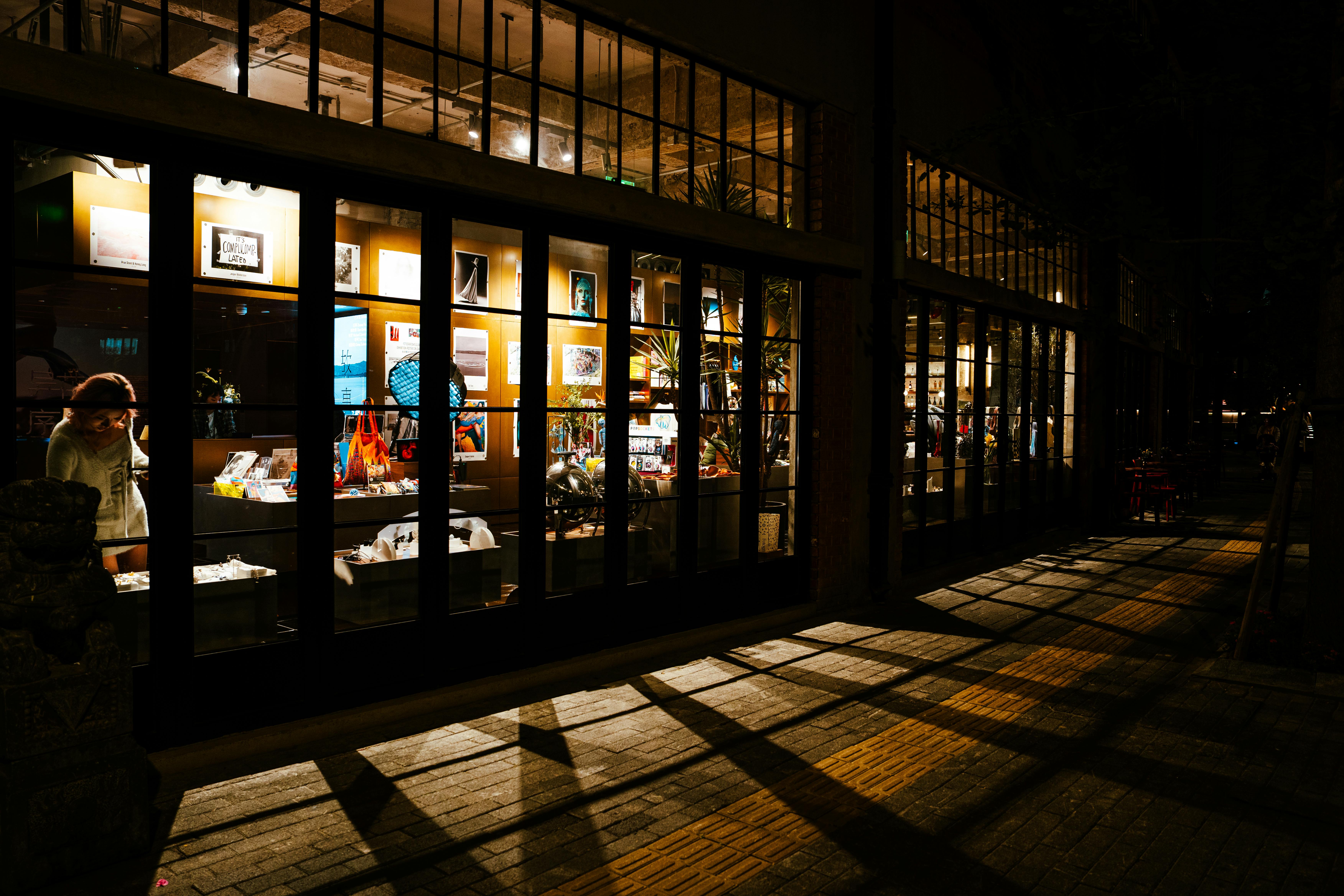 The Light from the Inside of a Building Illuminating the Sidewalk in a ...