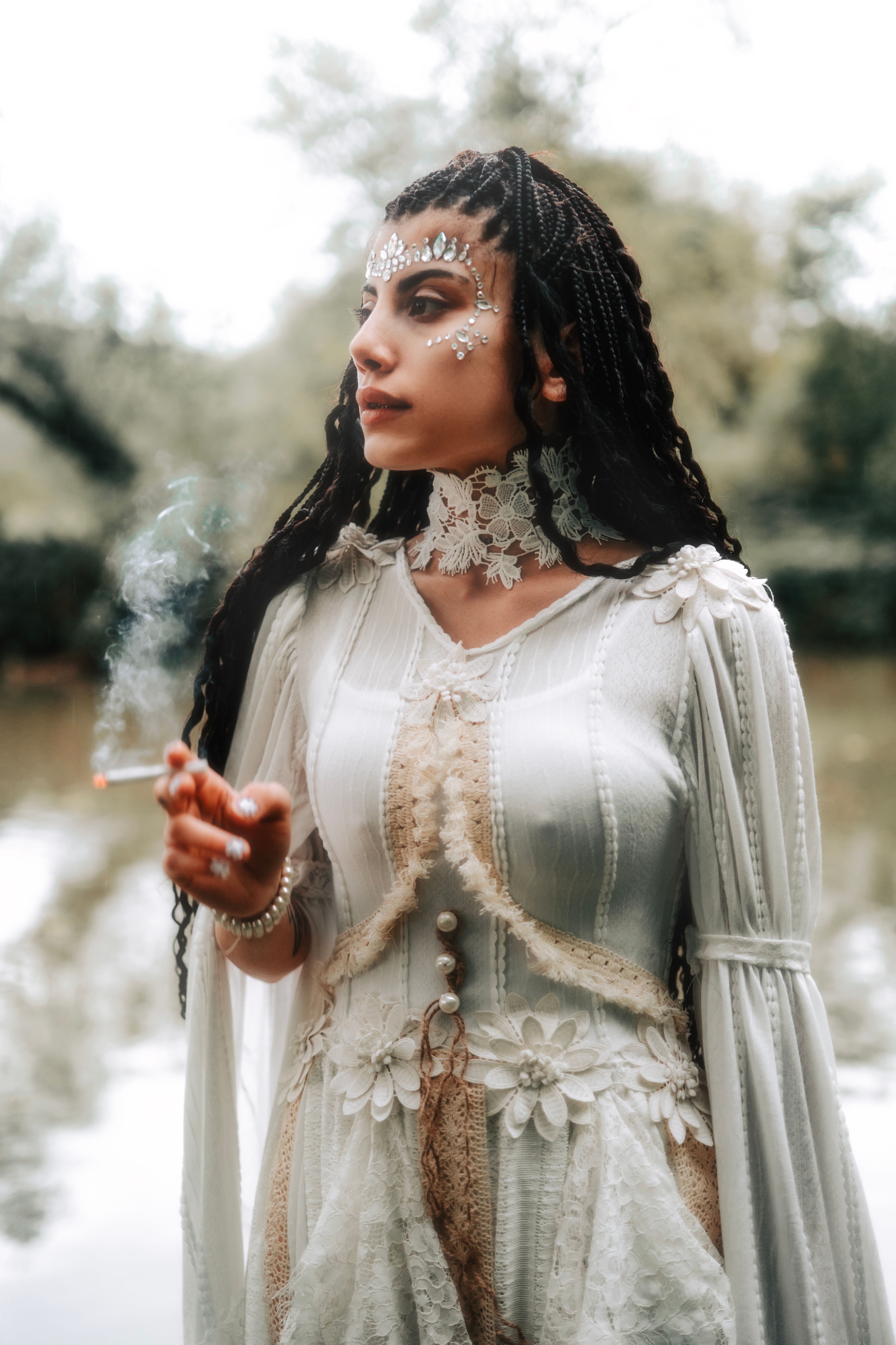 Brunette Woman in White Dress Smoking Cigarette · Free Stock Photo