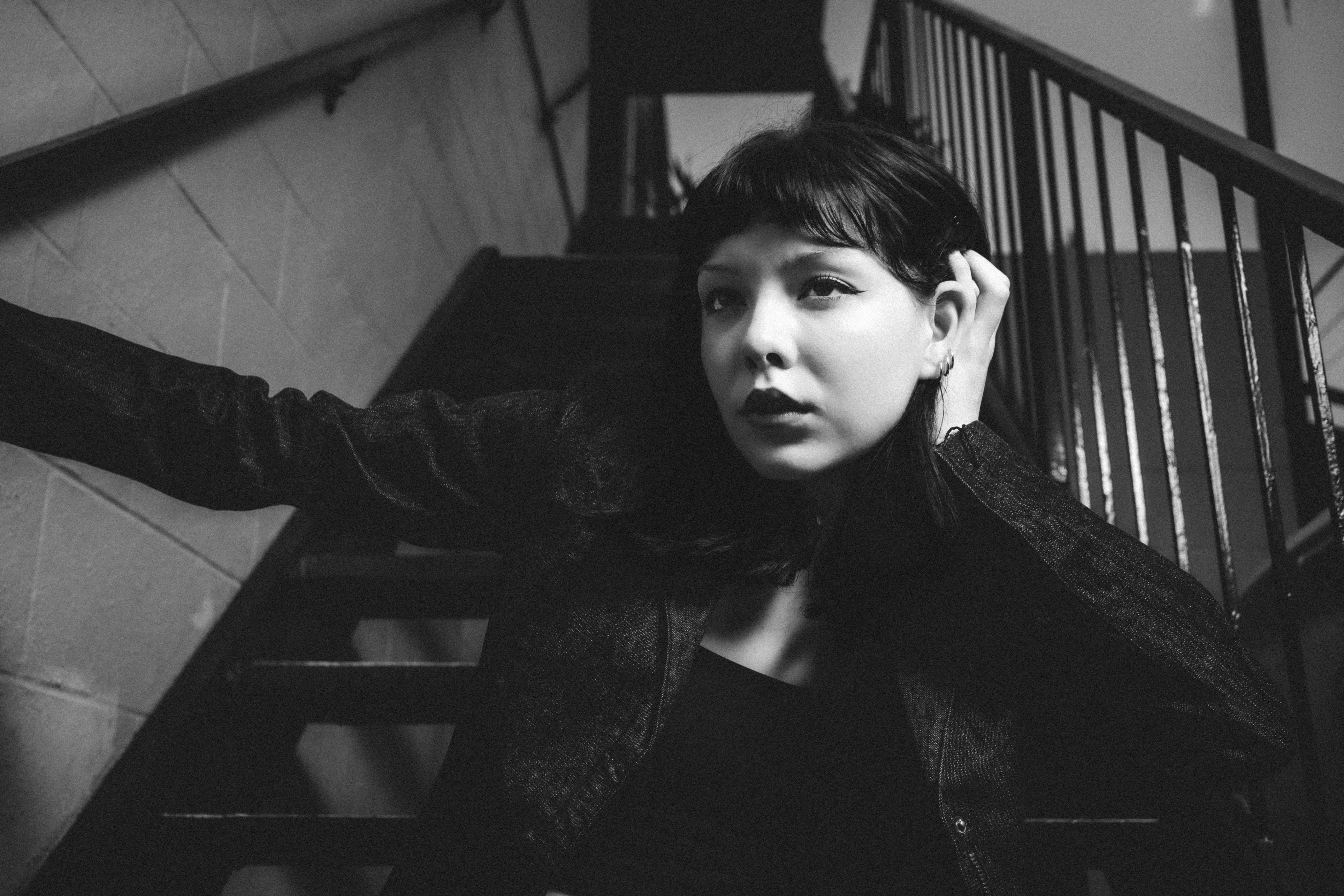Black and White Portrait of a Woman Sitting on Stairs · Free Stock Photo