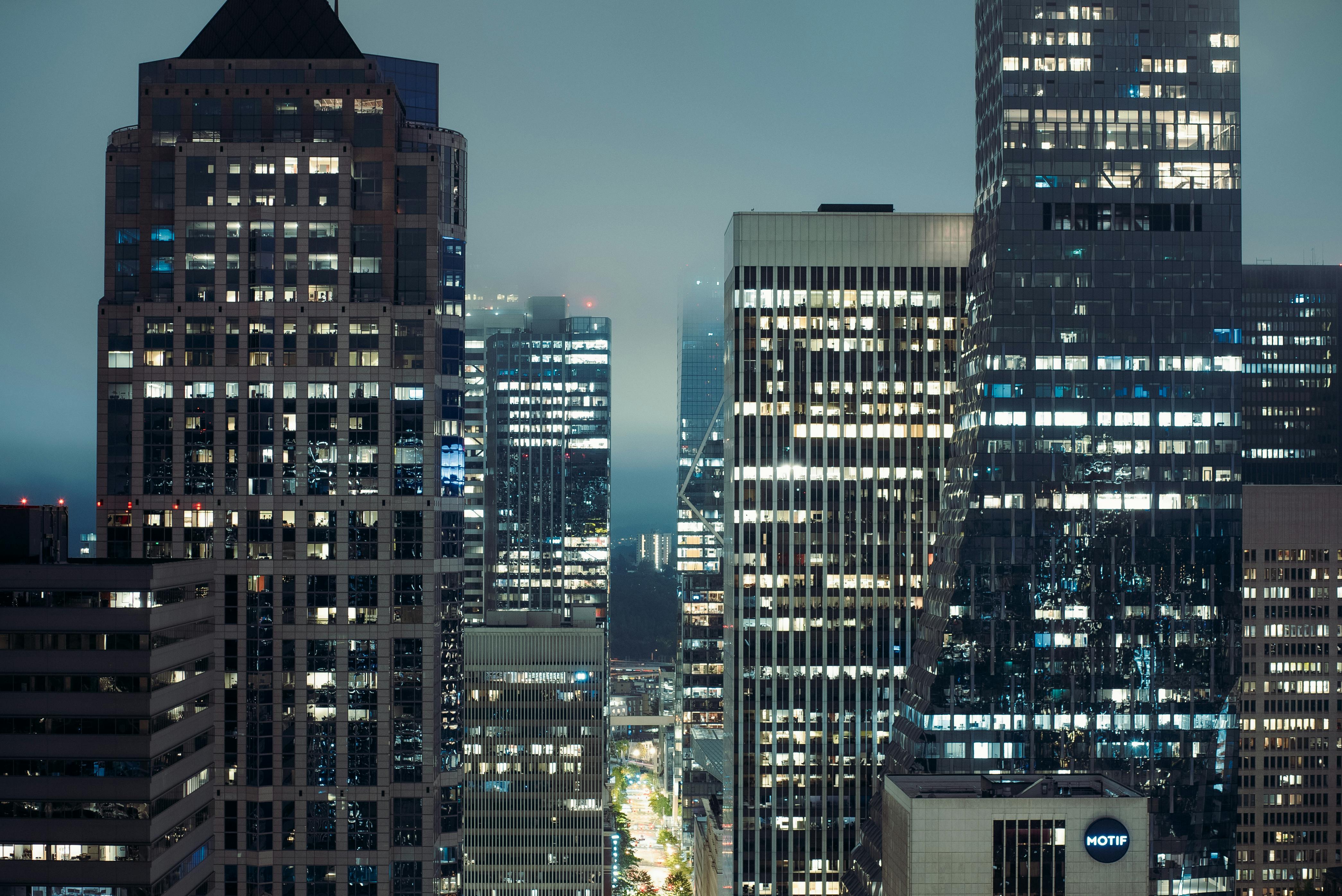 Cityscape with Tall Lit Buildings and Fog · Free Stock Photo