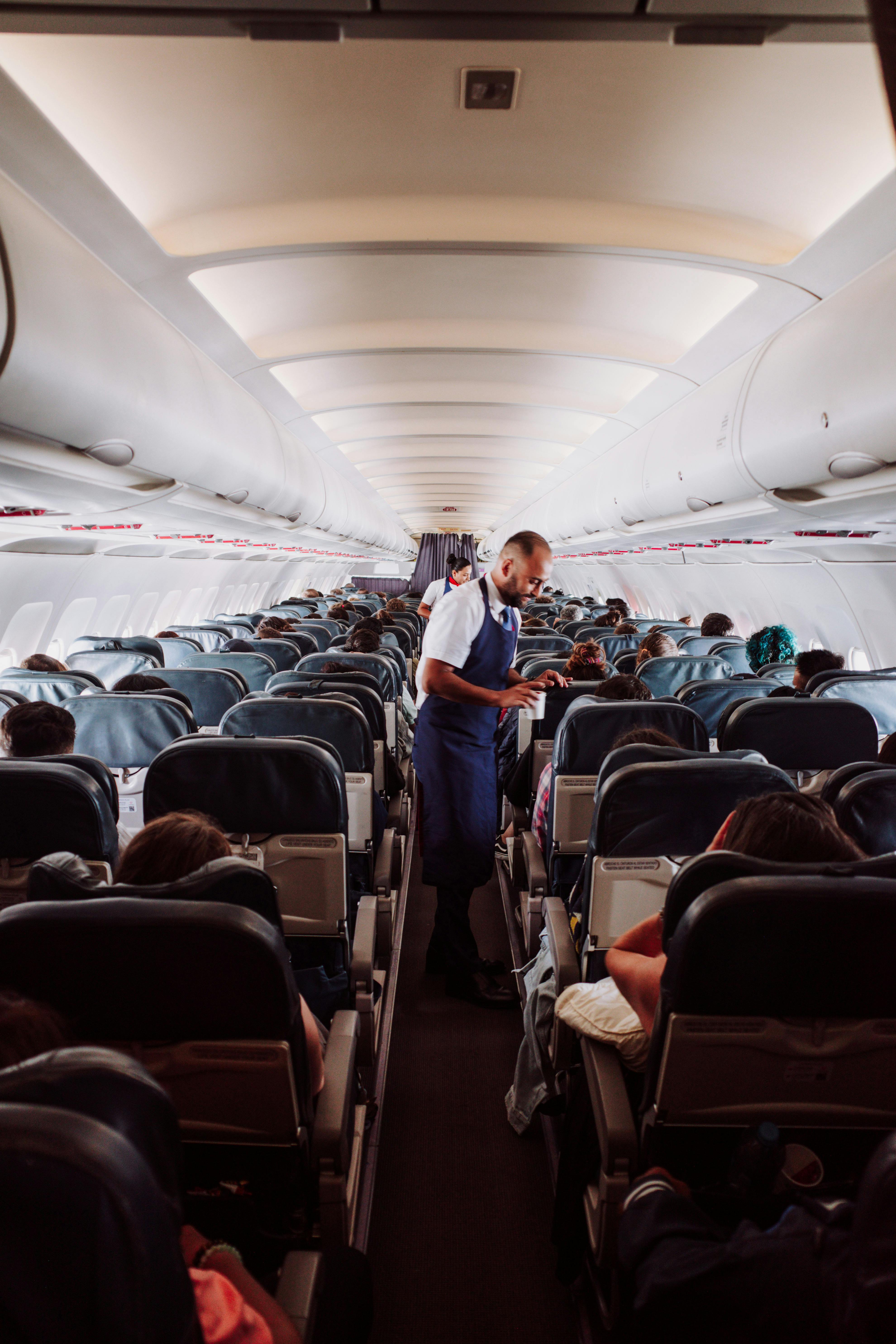 Person Standing Inside Airliner · Free Stock Photo