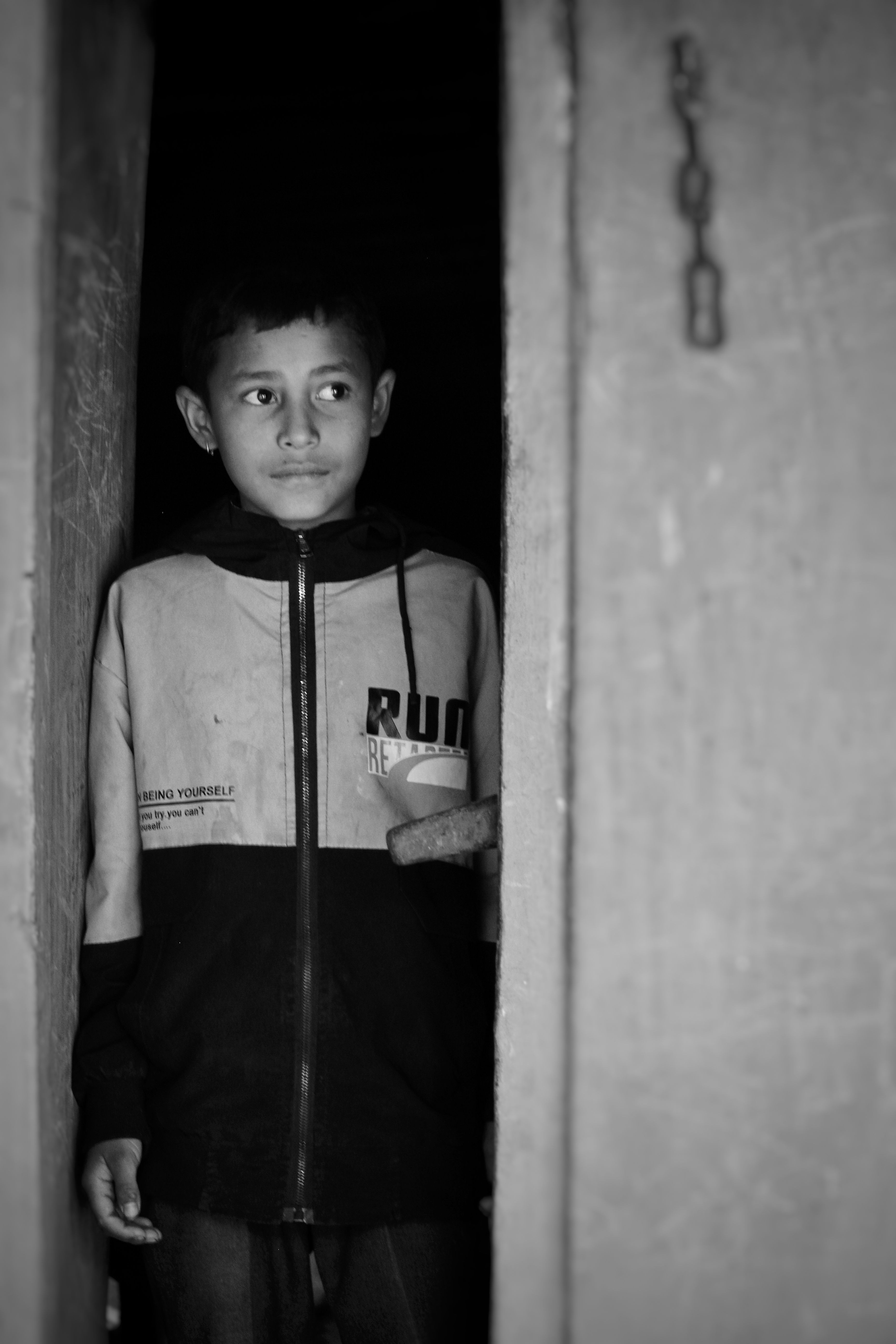 Scared Boy Standing in Doorway · Free Stock Photo