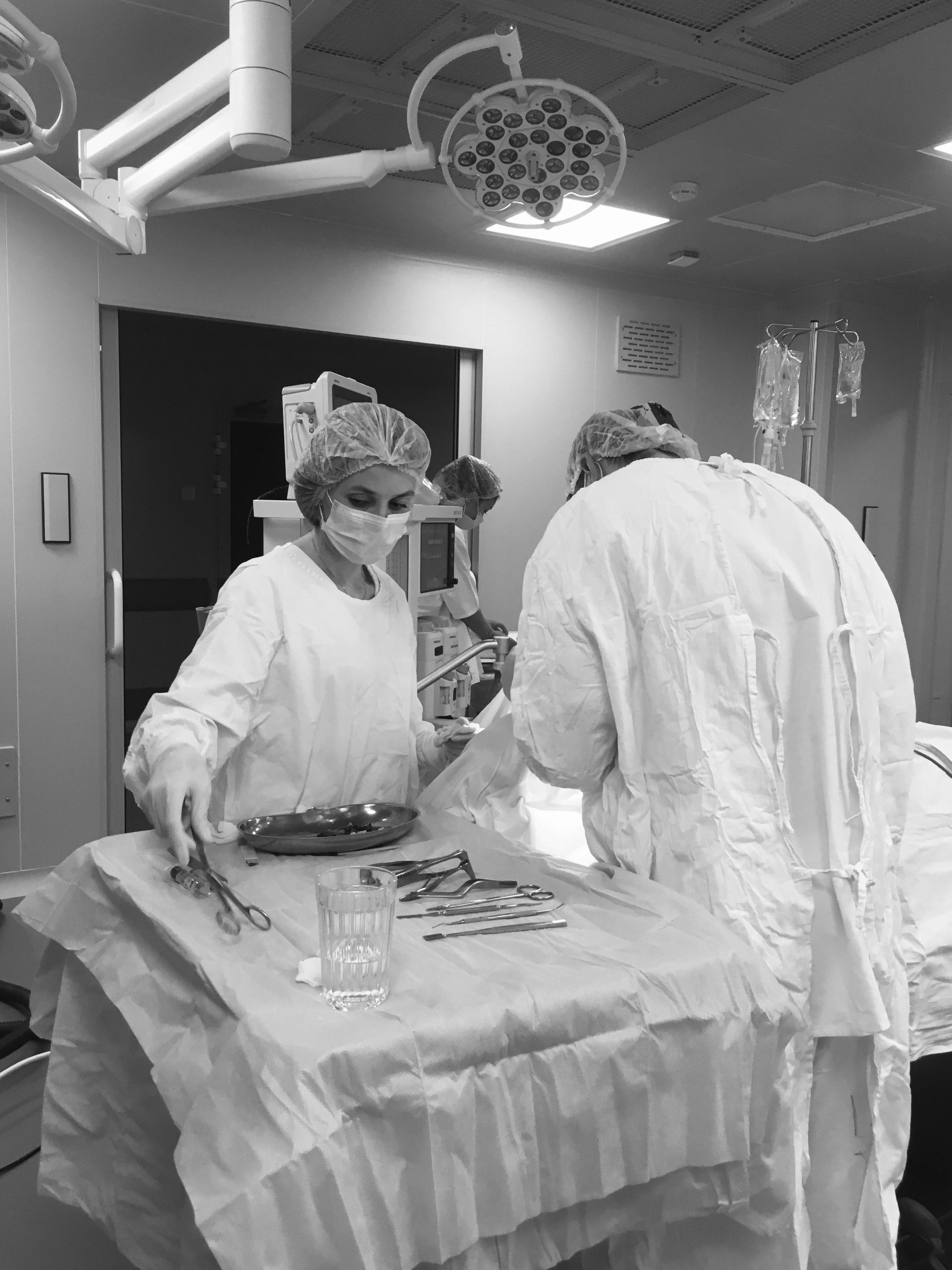 Surgeons Performing Surgery on a Patient in Operating Room, Black And ...