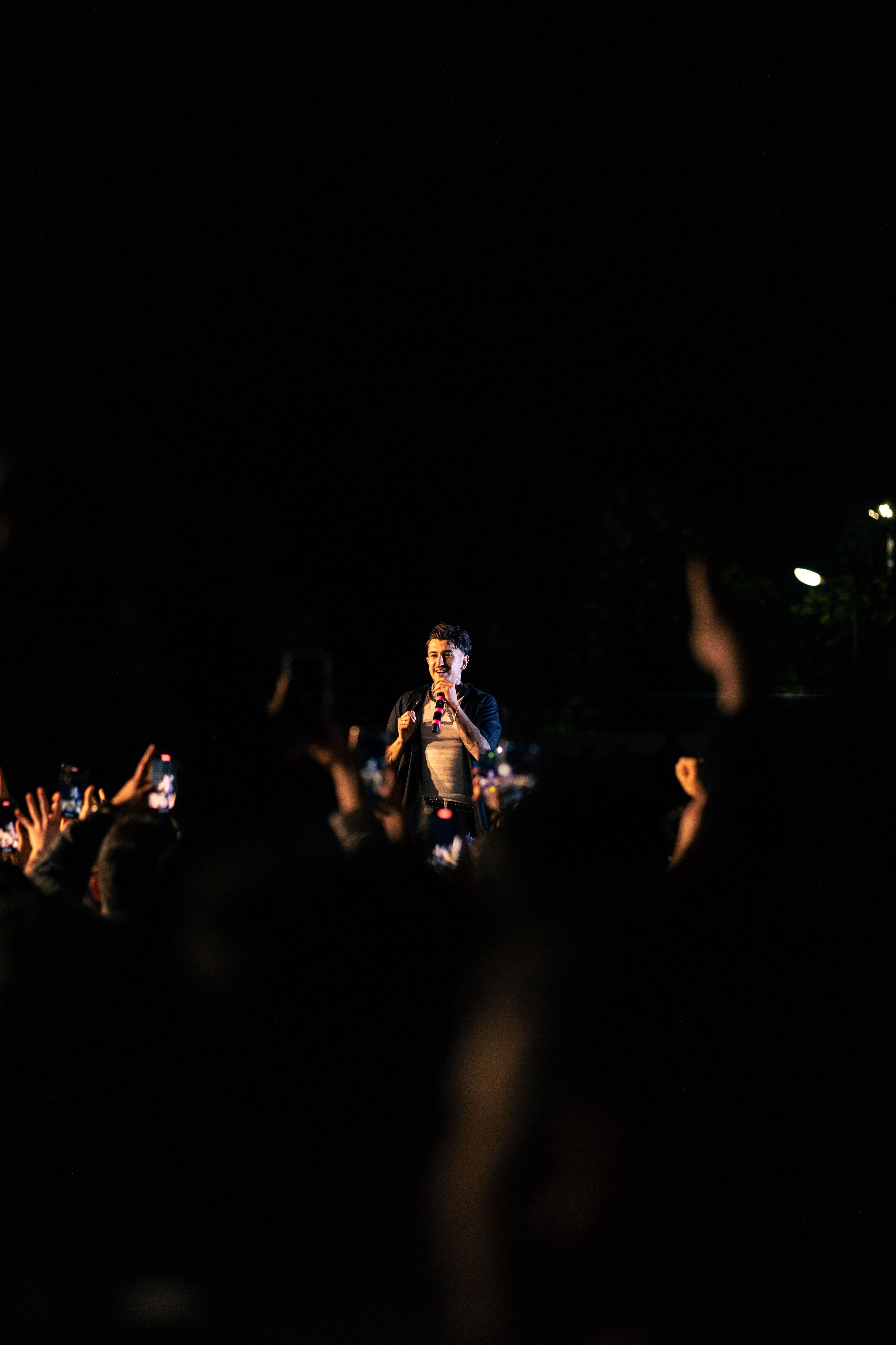 A Singer Standing among the Crowd at a Concert · Free Stock Photo