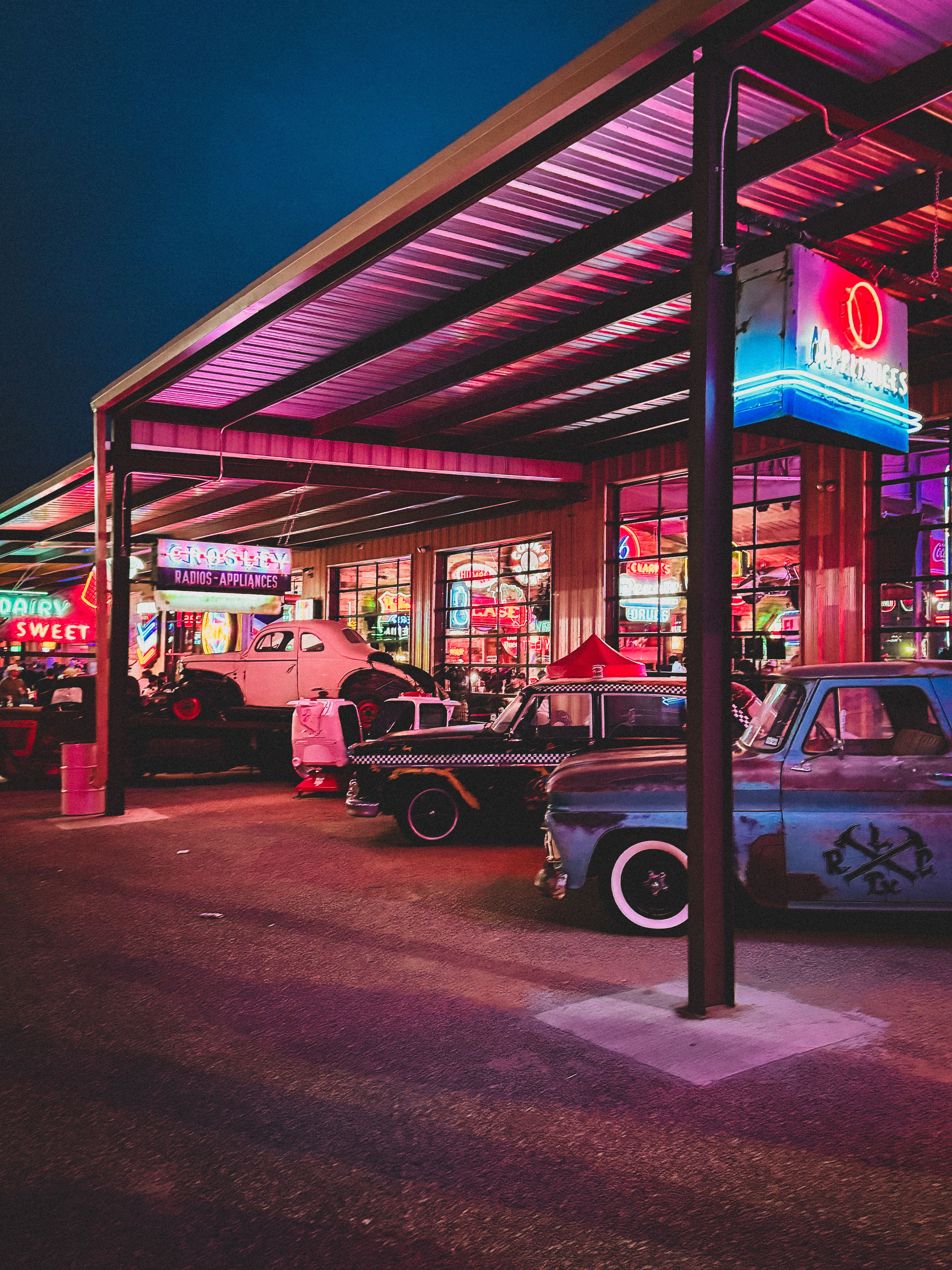 Vintage Cars in Front of a Retro Restaurant in the Light of Neon Signs ...