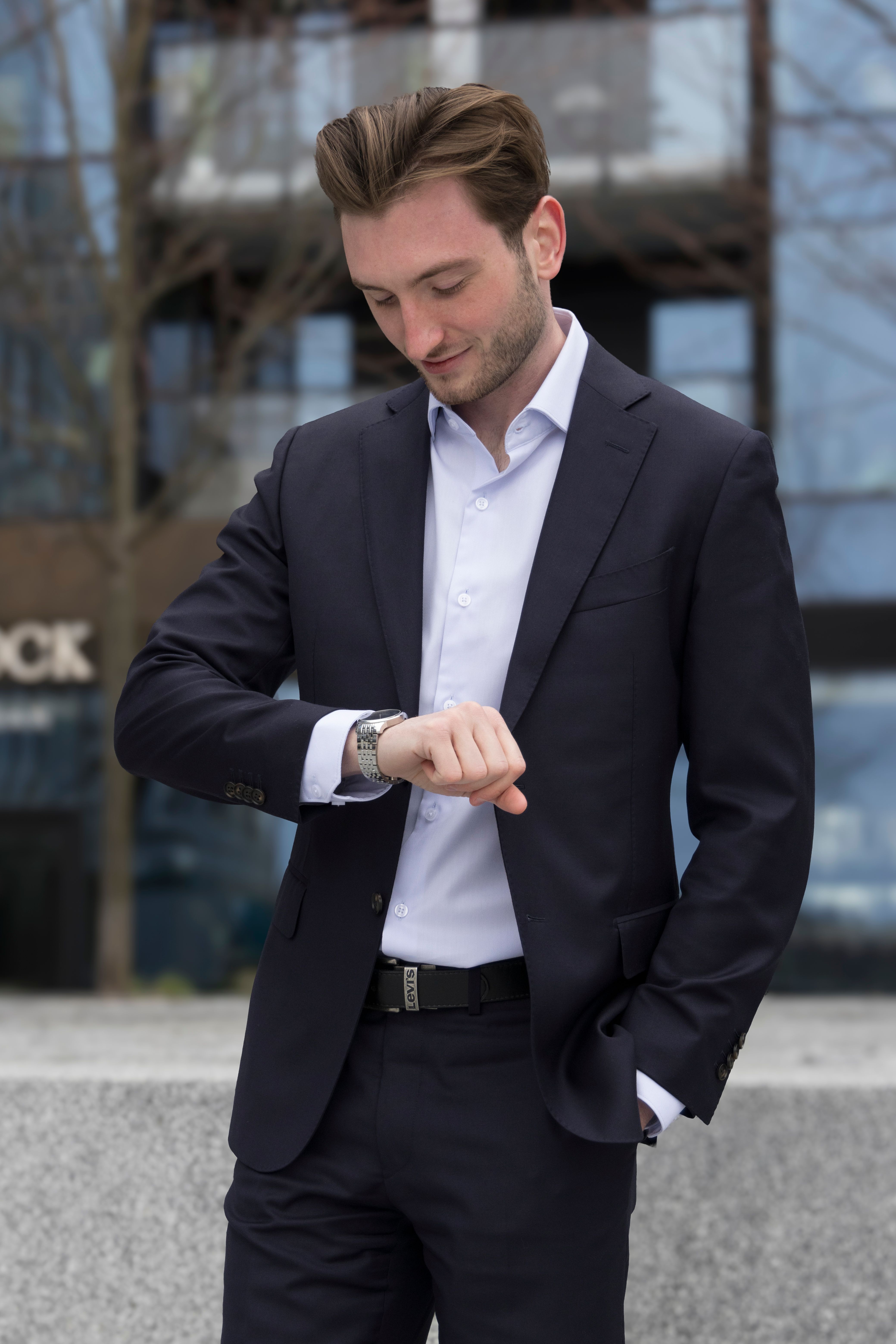 Businessman Checking Time on Wristwatch · Free Stock Photo