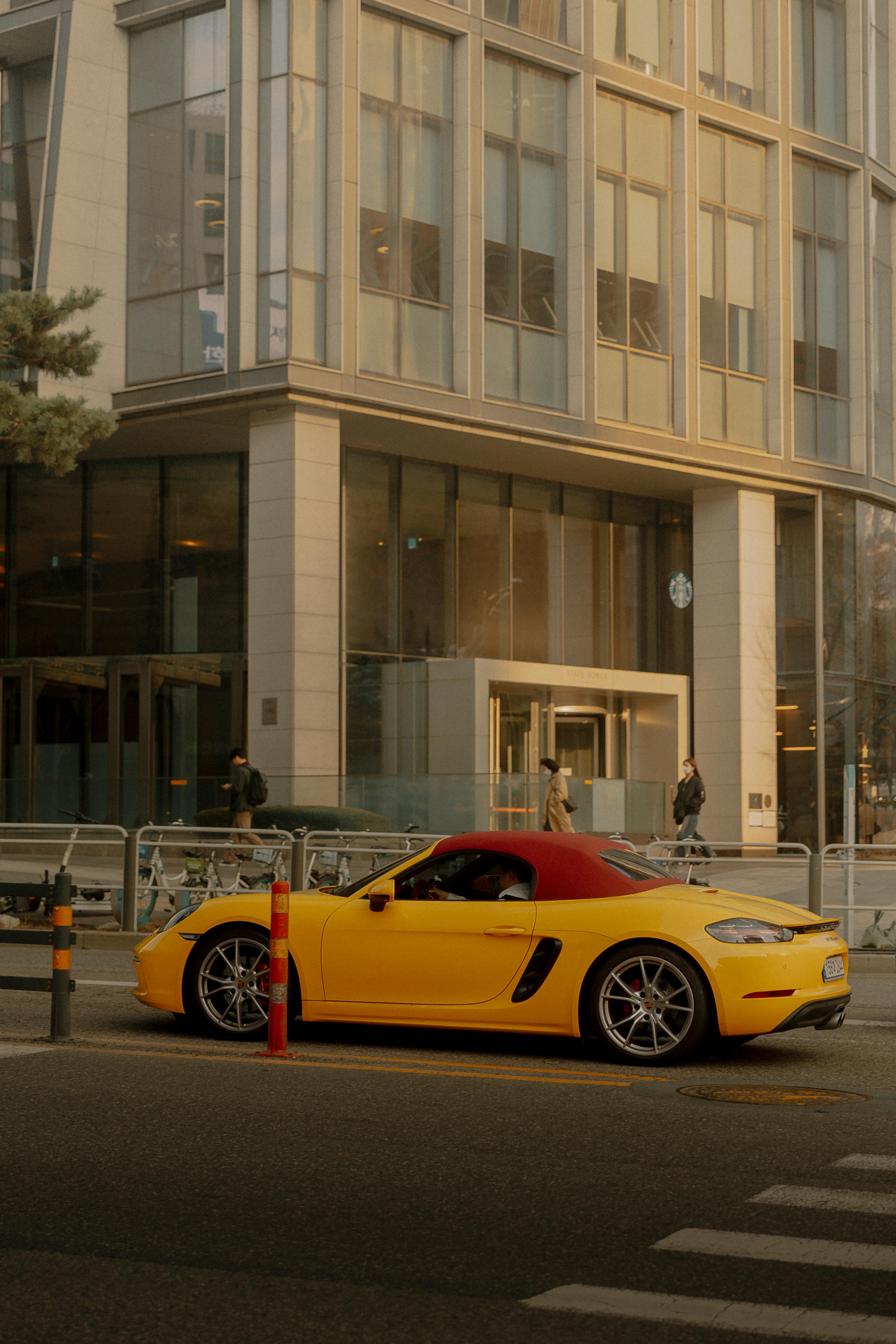 A Yellow Luxury Car on a Street in a City · Free Stock Photo