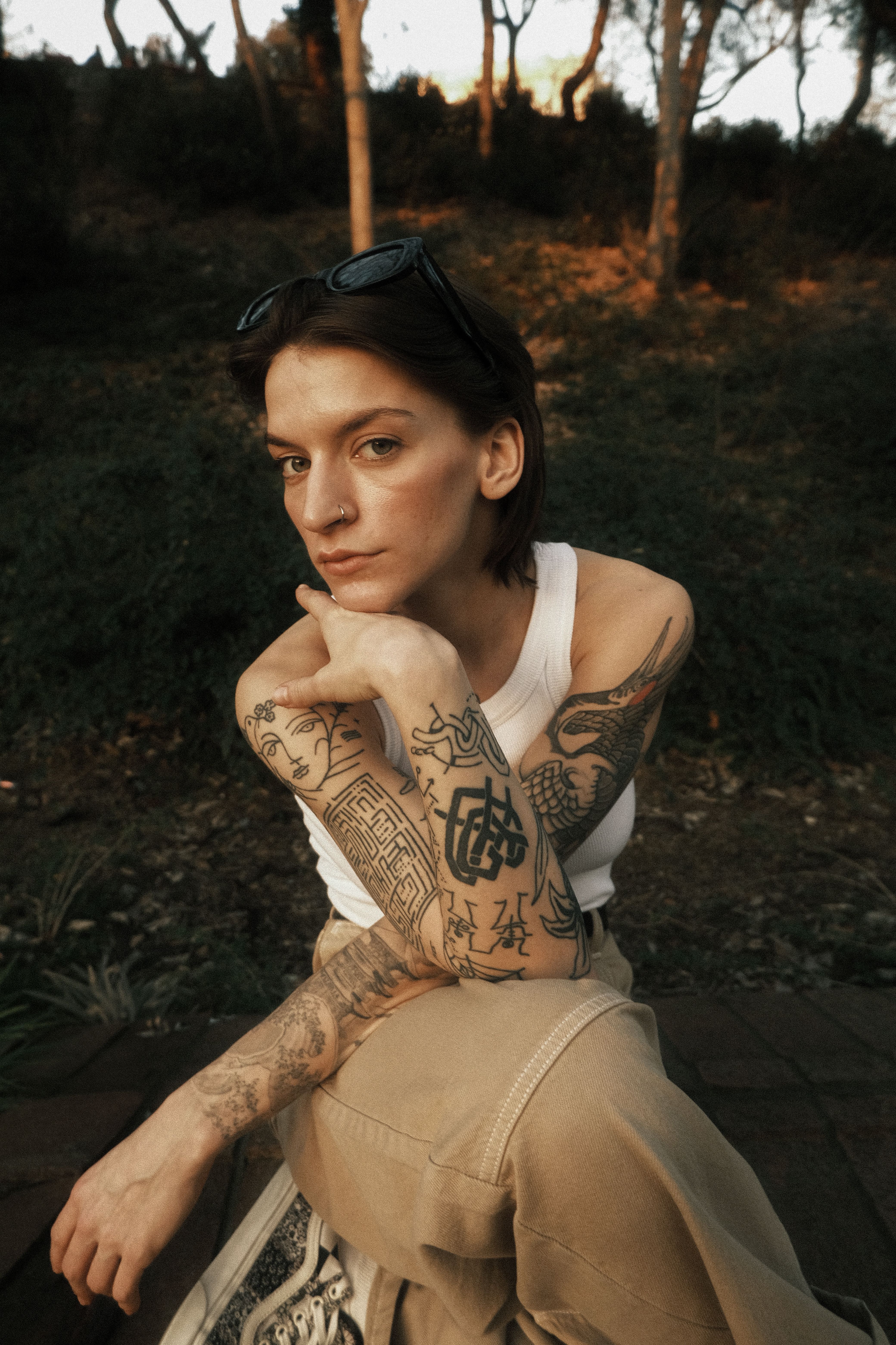 Woman with Tattoos Sitting in Forest · Free Stock Photo