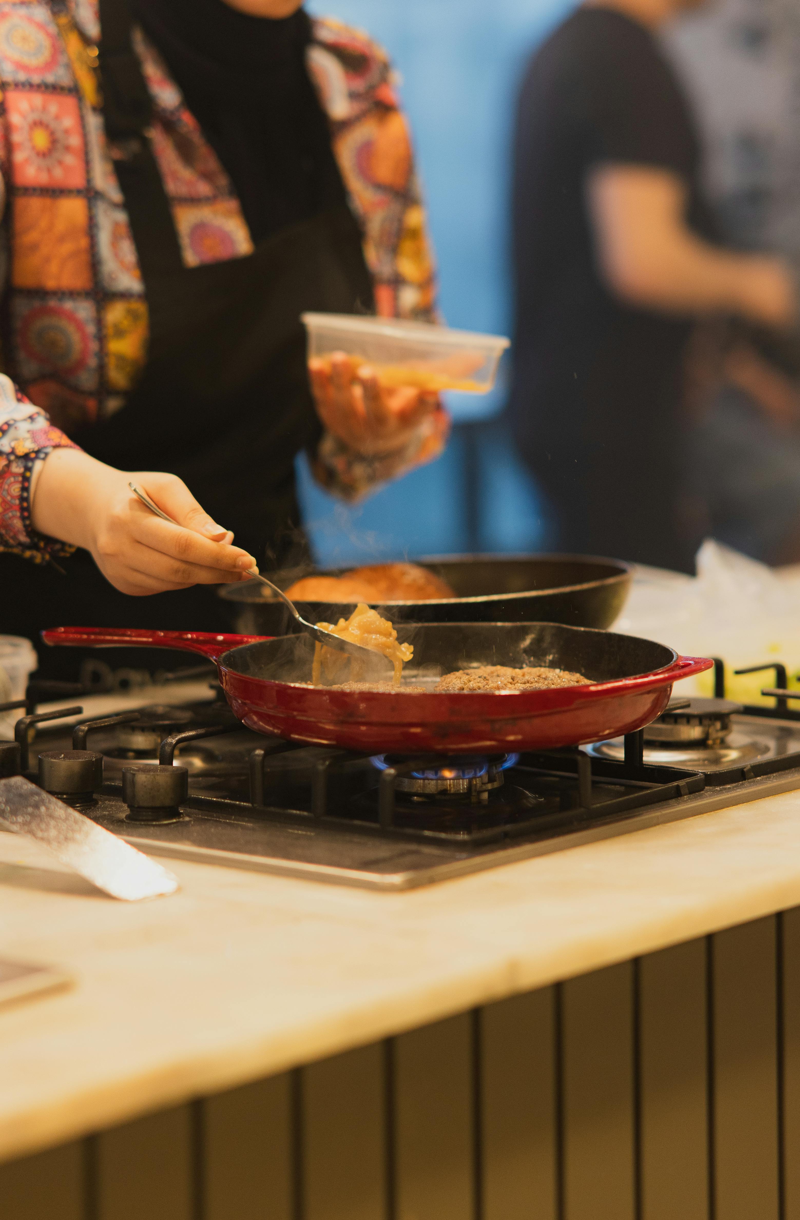 Woman Eating on Cooking Pan · Free Stock Photo