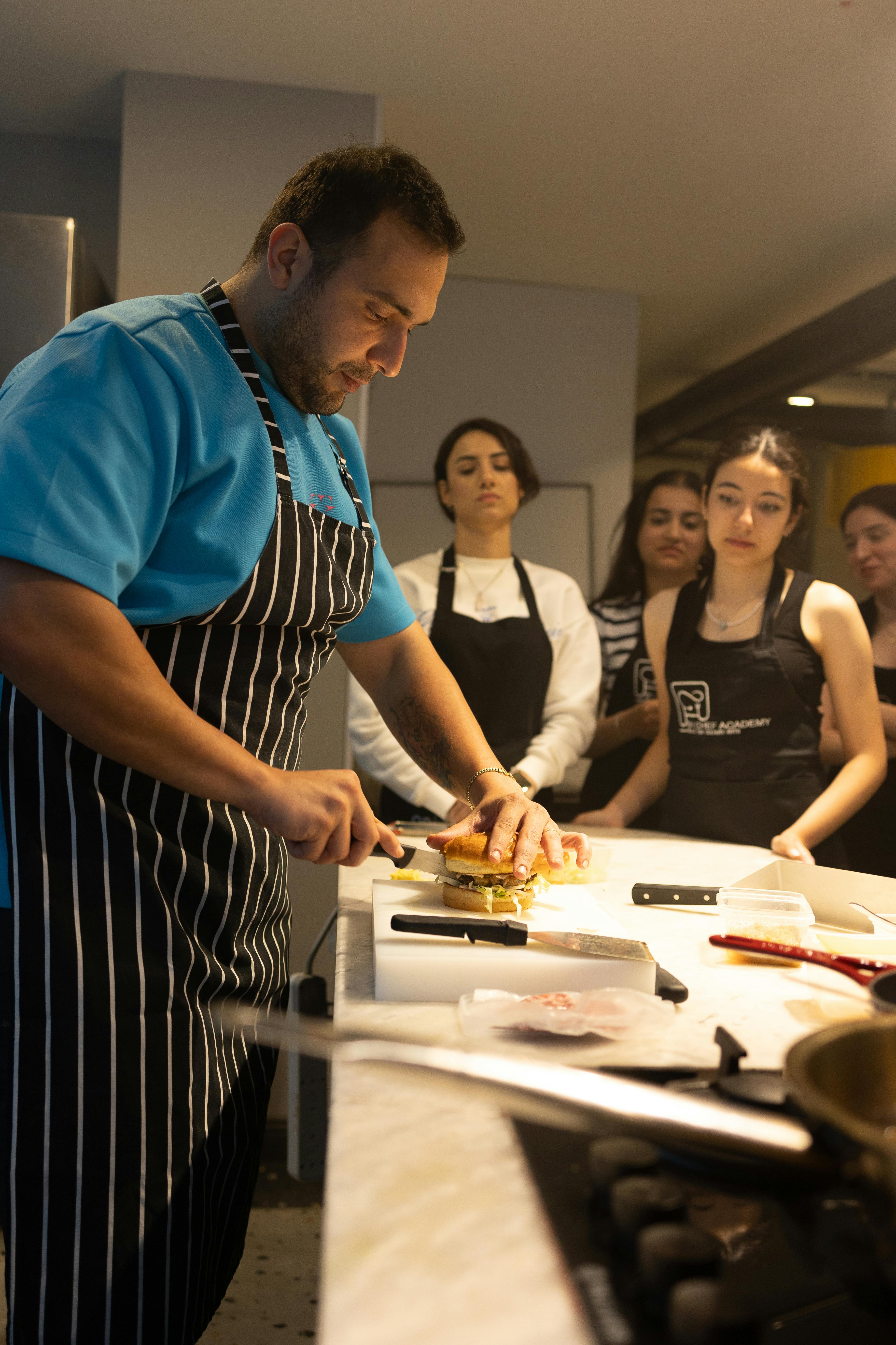 People Looking at a Chef Making a Burger · Free Stock Photo
