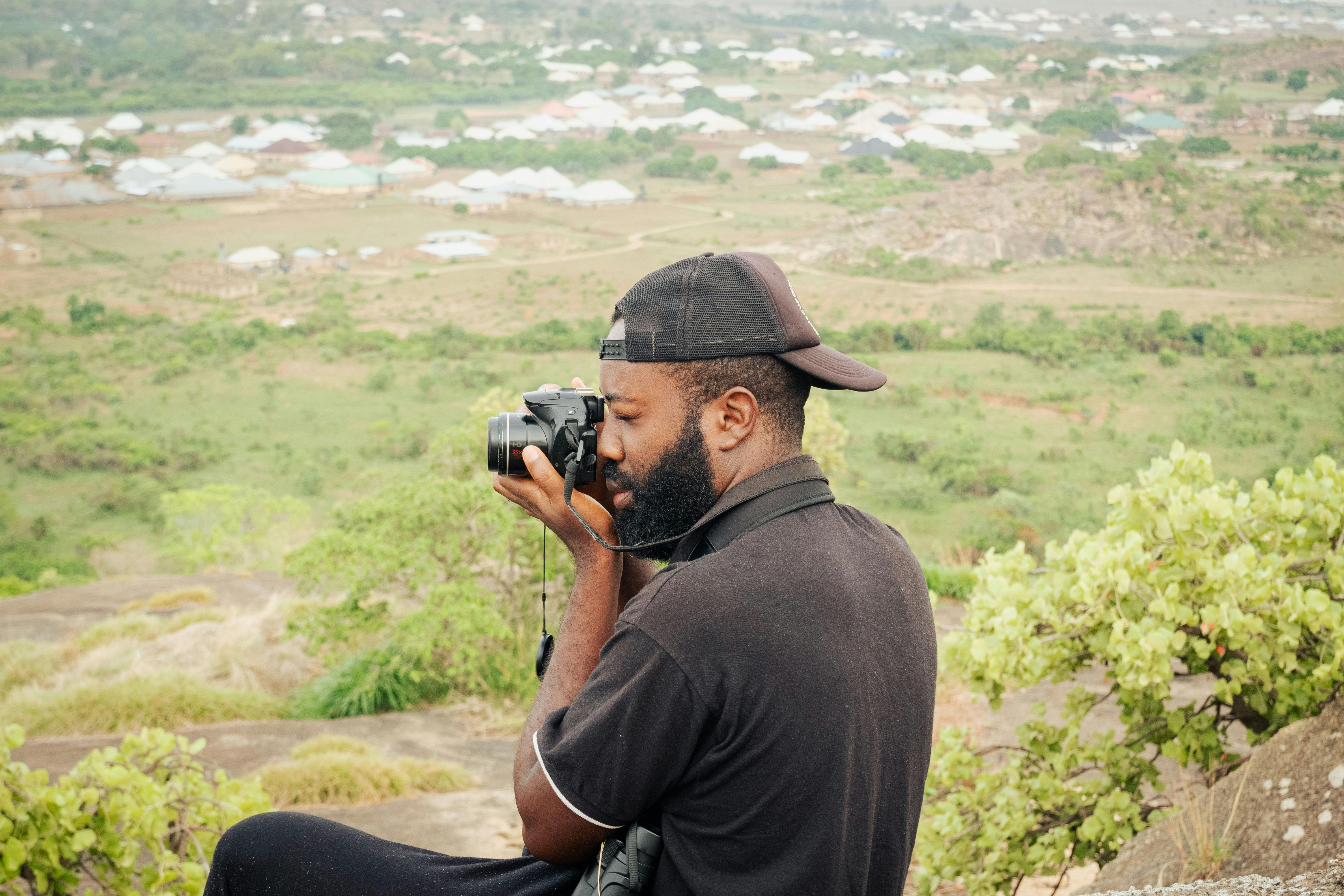 Man Taking Photos on a Field · Free Stock Photo