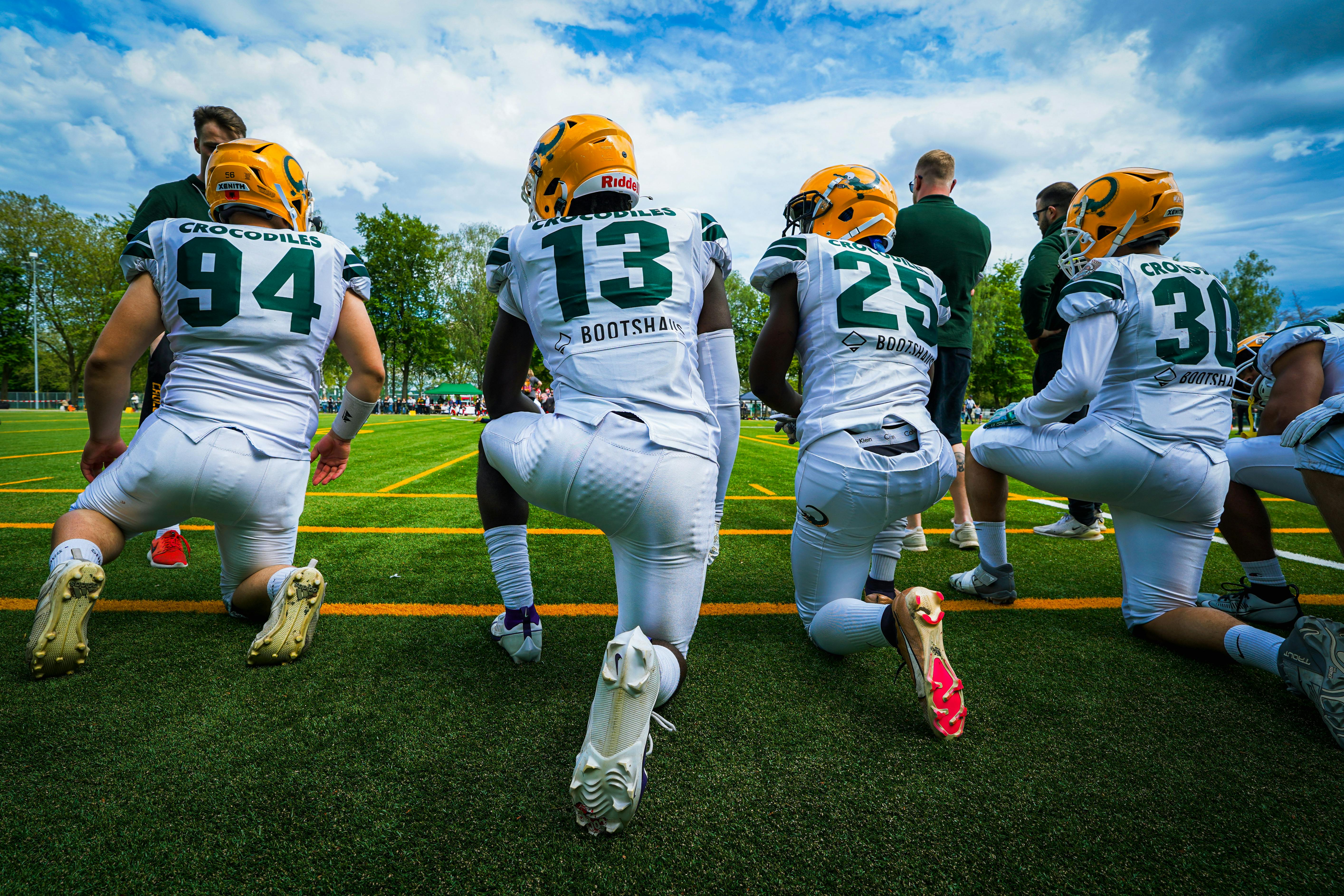 American Footballers Crouching on Field · Free Stock Photo