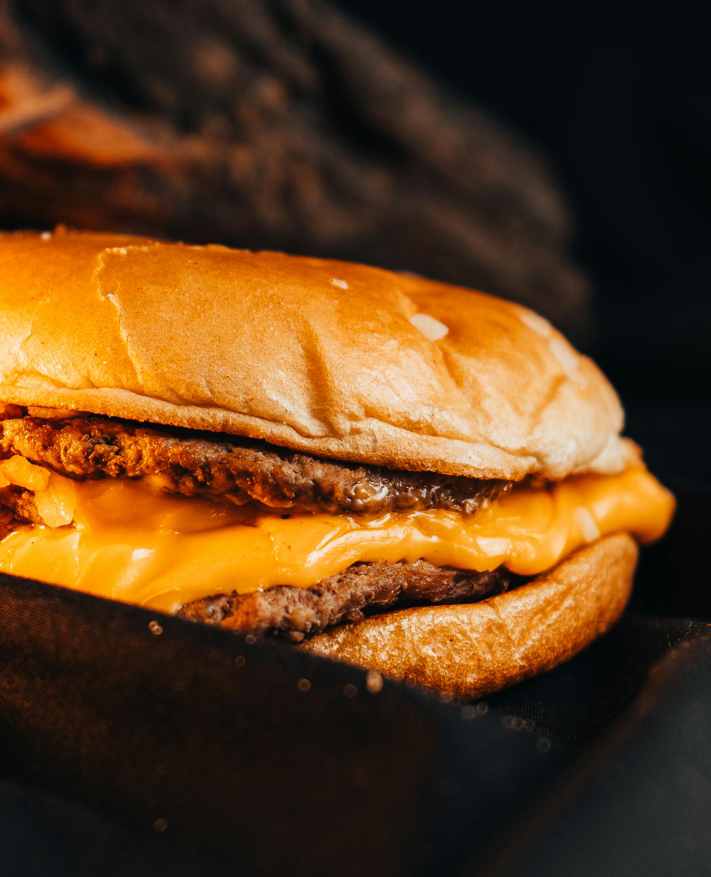 Massive Cheeseburger on Cutting Board · Free Stock Photo