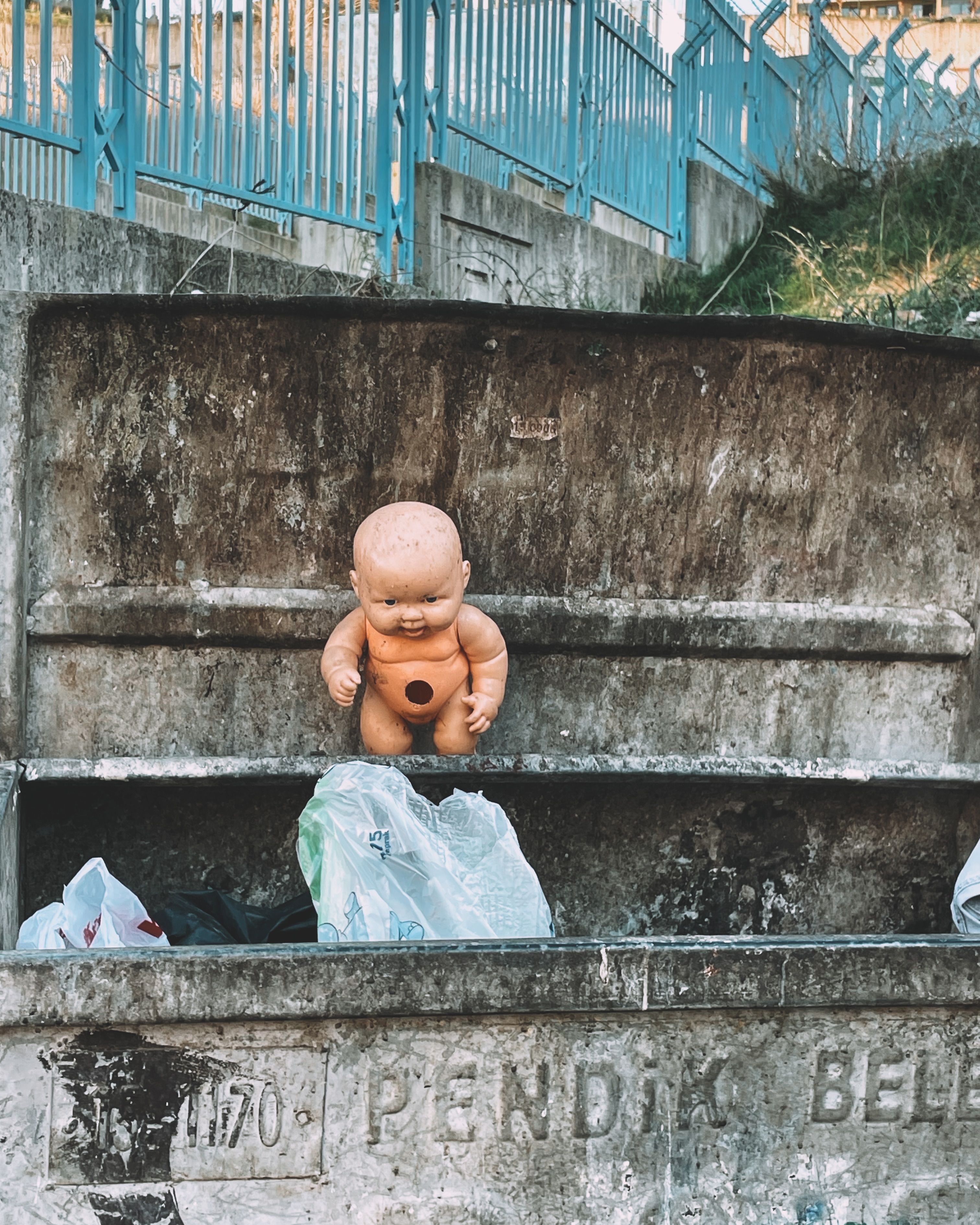 Doll in a Garbage Can · Free Stock Photo