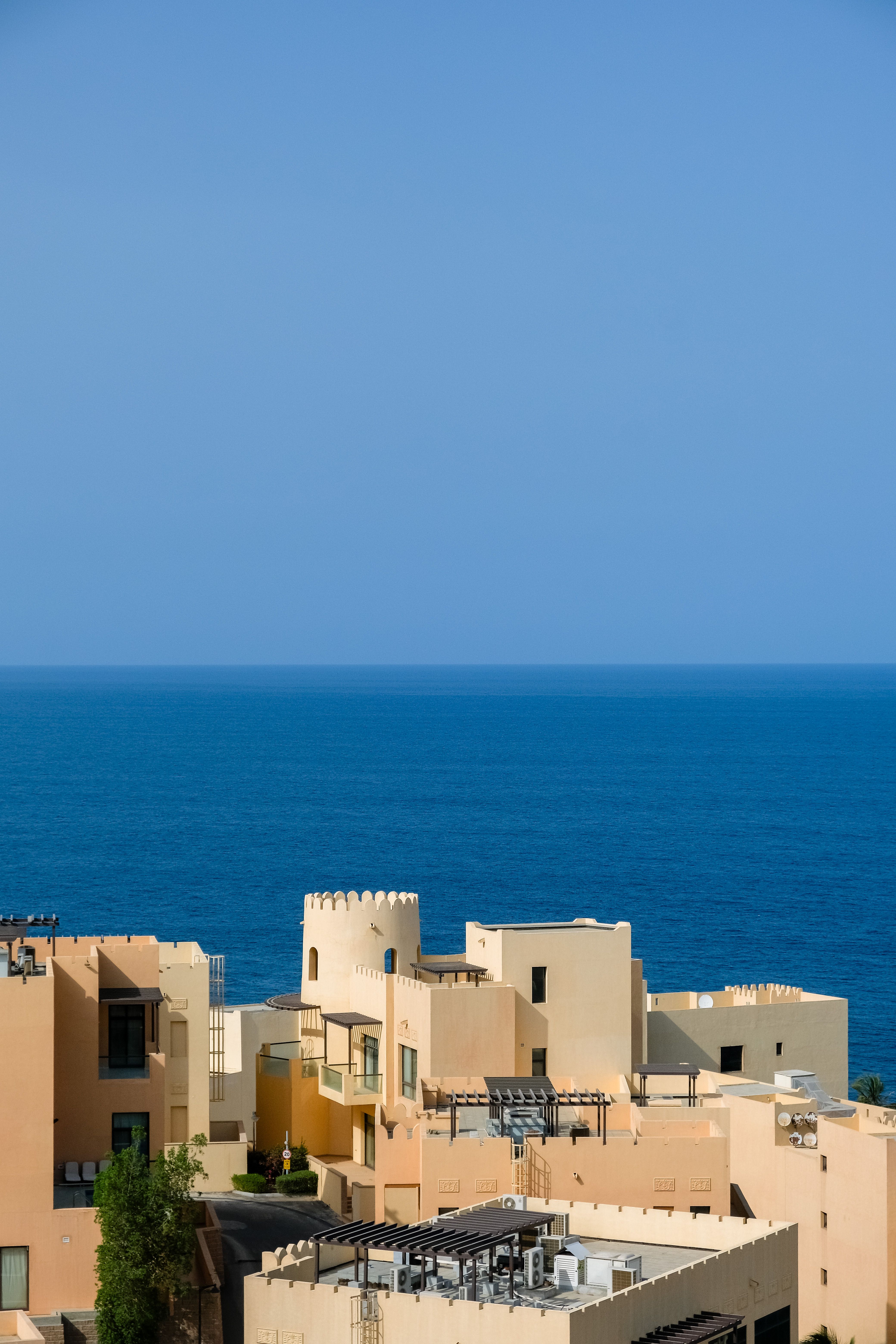 Simple Beige Houses next to Sea · Free Stock Photo