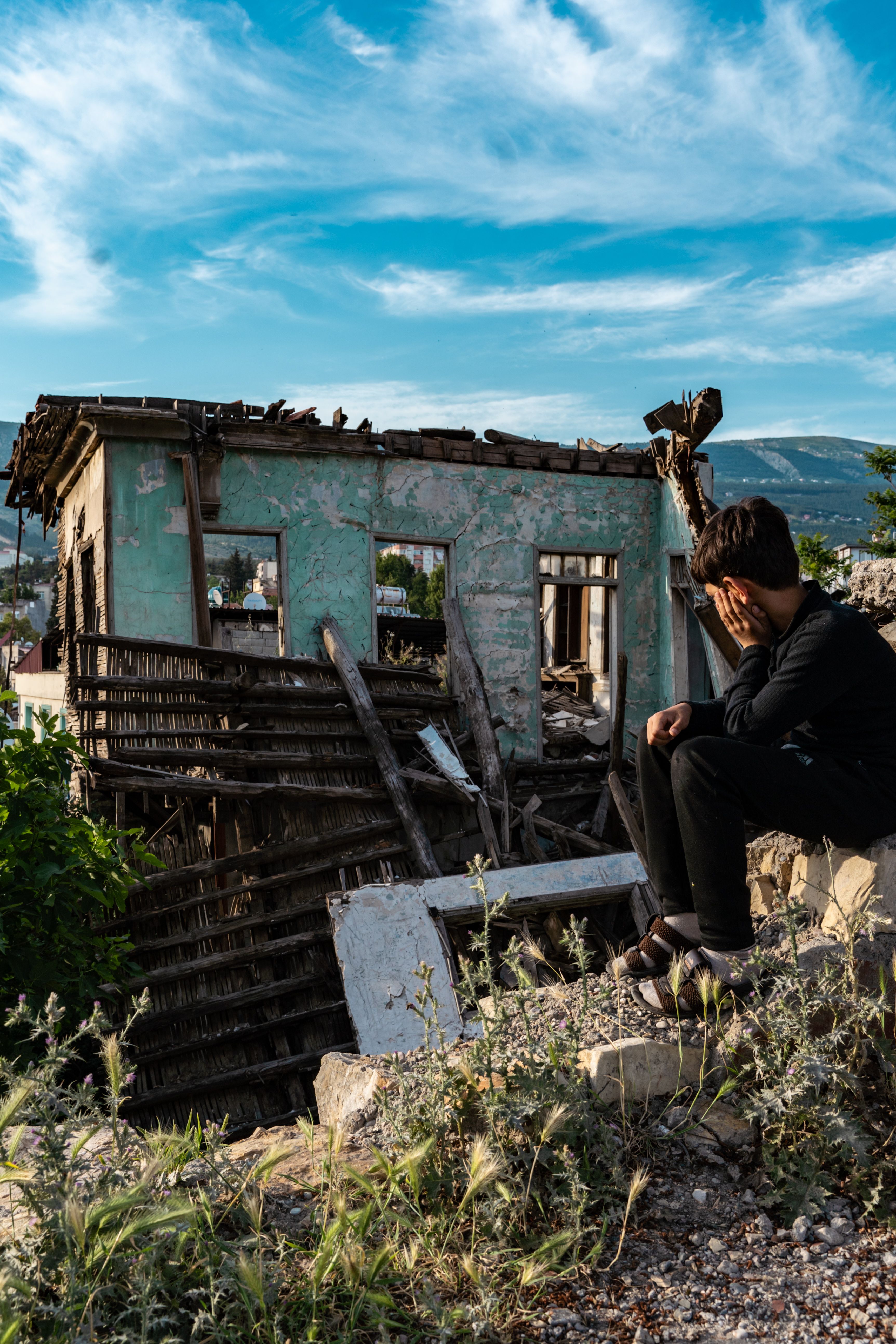 Boy by Ruins of House · Free Stock Photo