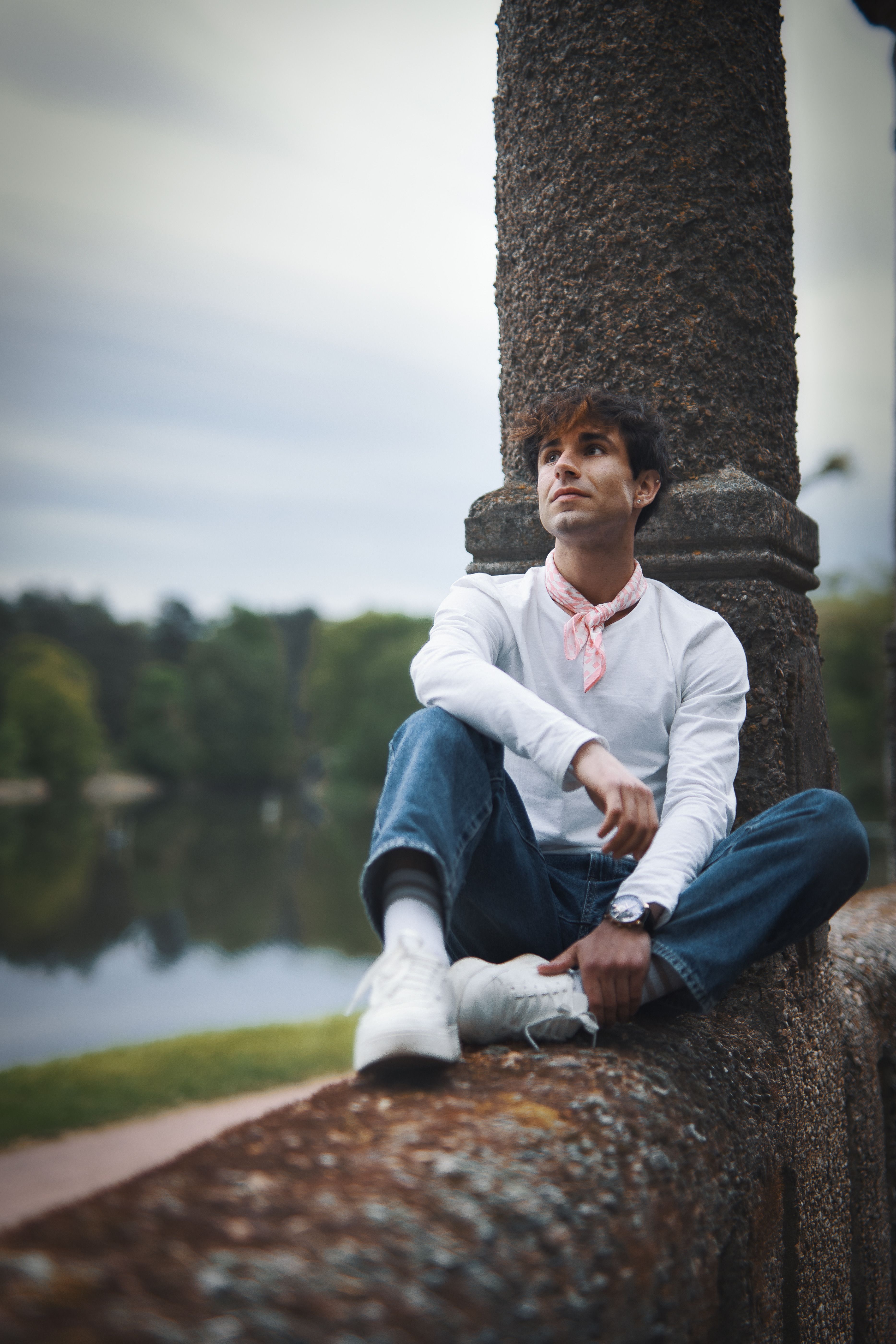 Man Sitting on Rusty Bridge Railing under Column · Free Stock Photo