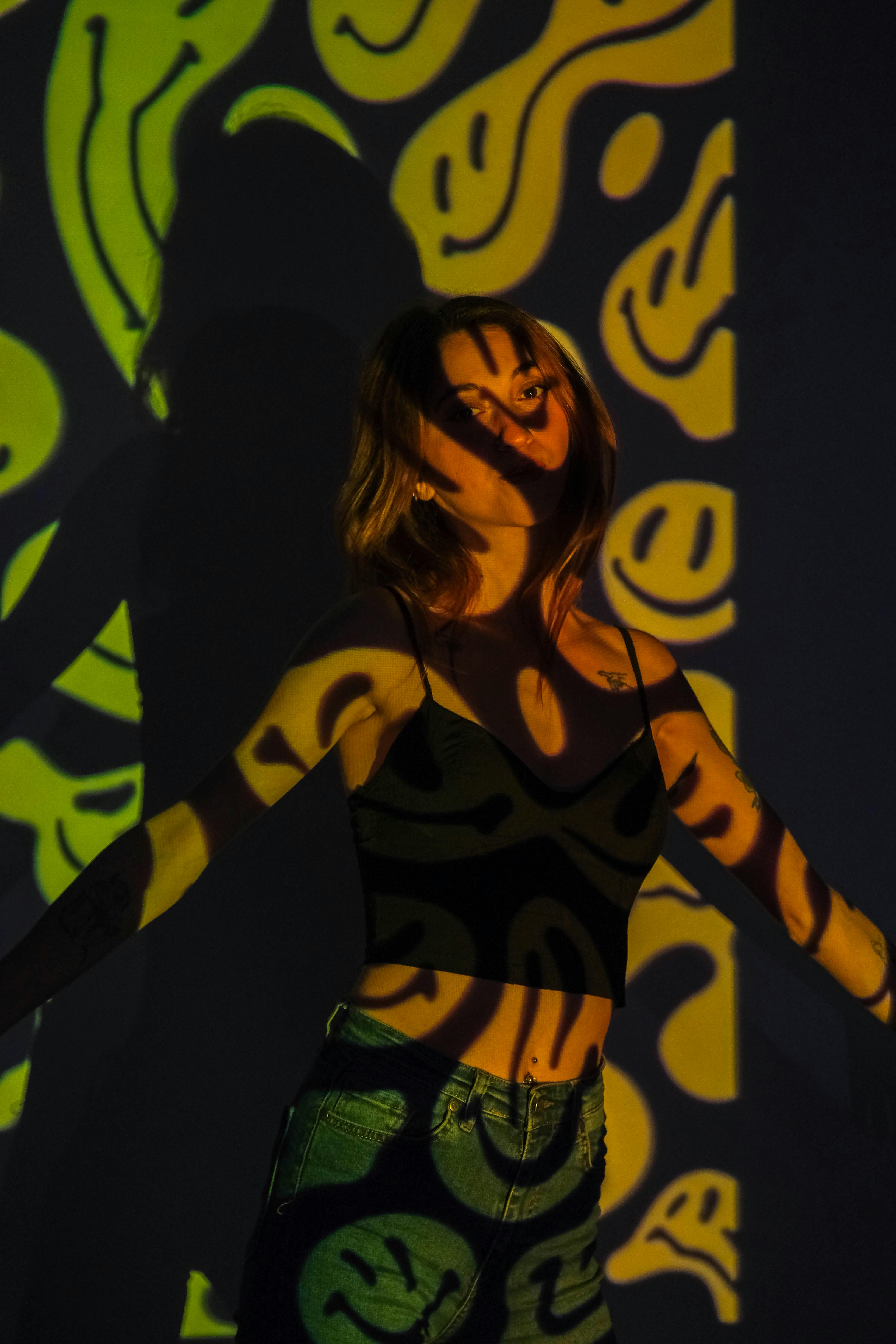 Smiley Faces Superimposed on Woman Standing under Wall · Free Stock Photo