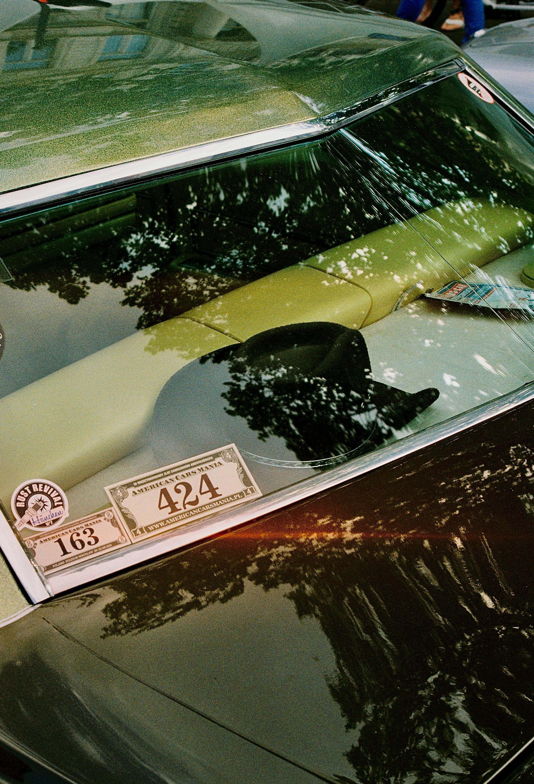 Rear Window of Vintage Car with Black Cowboy Hat Lying · Free Stock Photo
