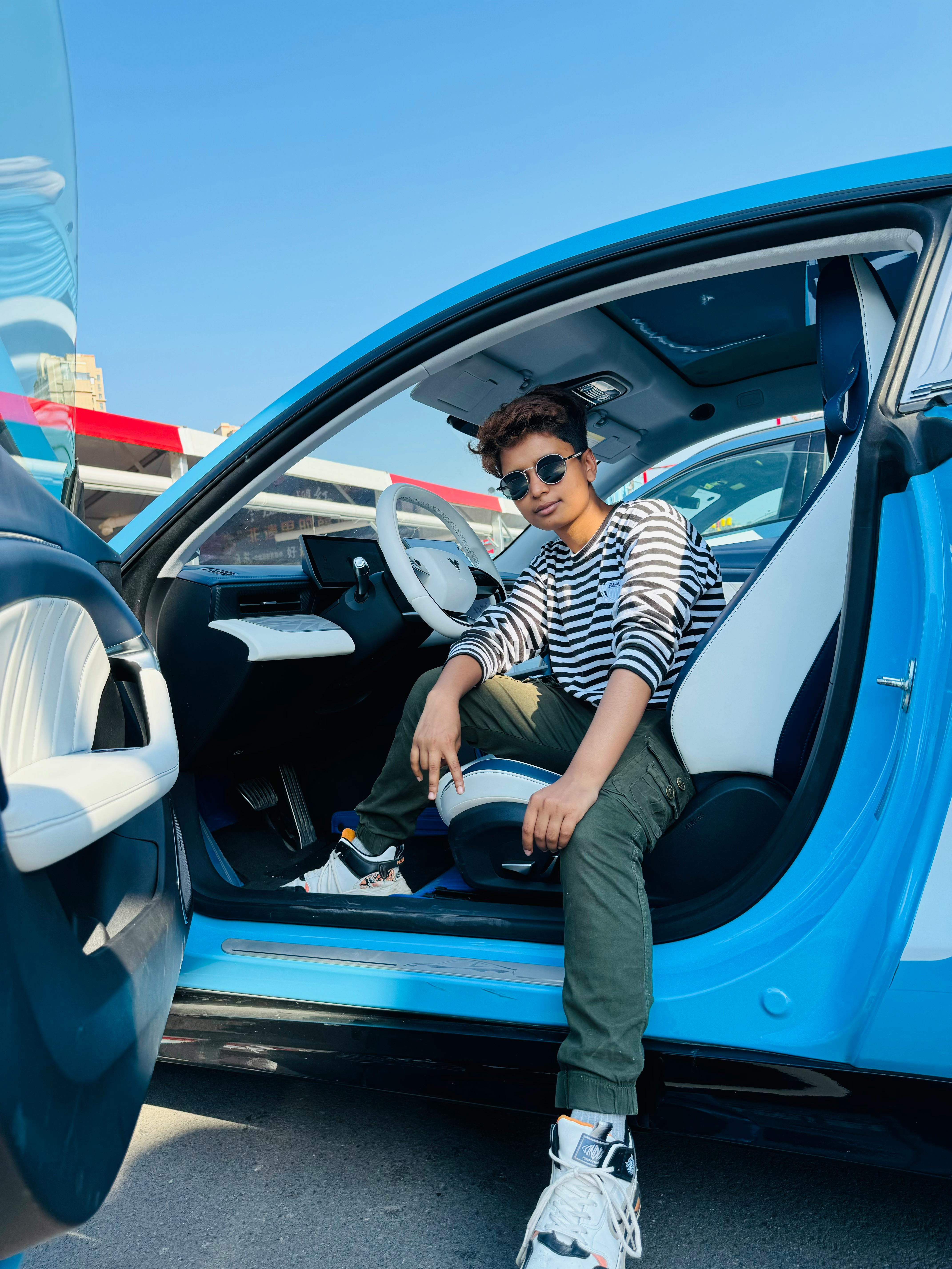 blue car inside setting boy · Free Stock Photo
