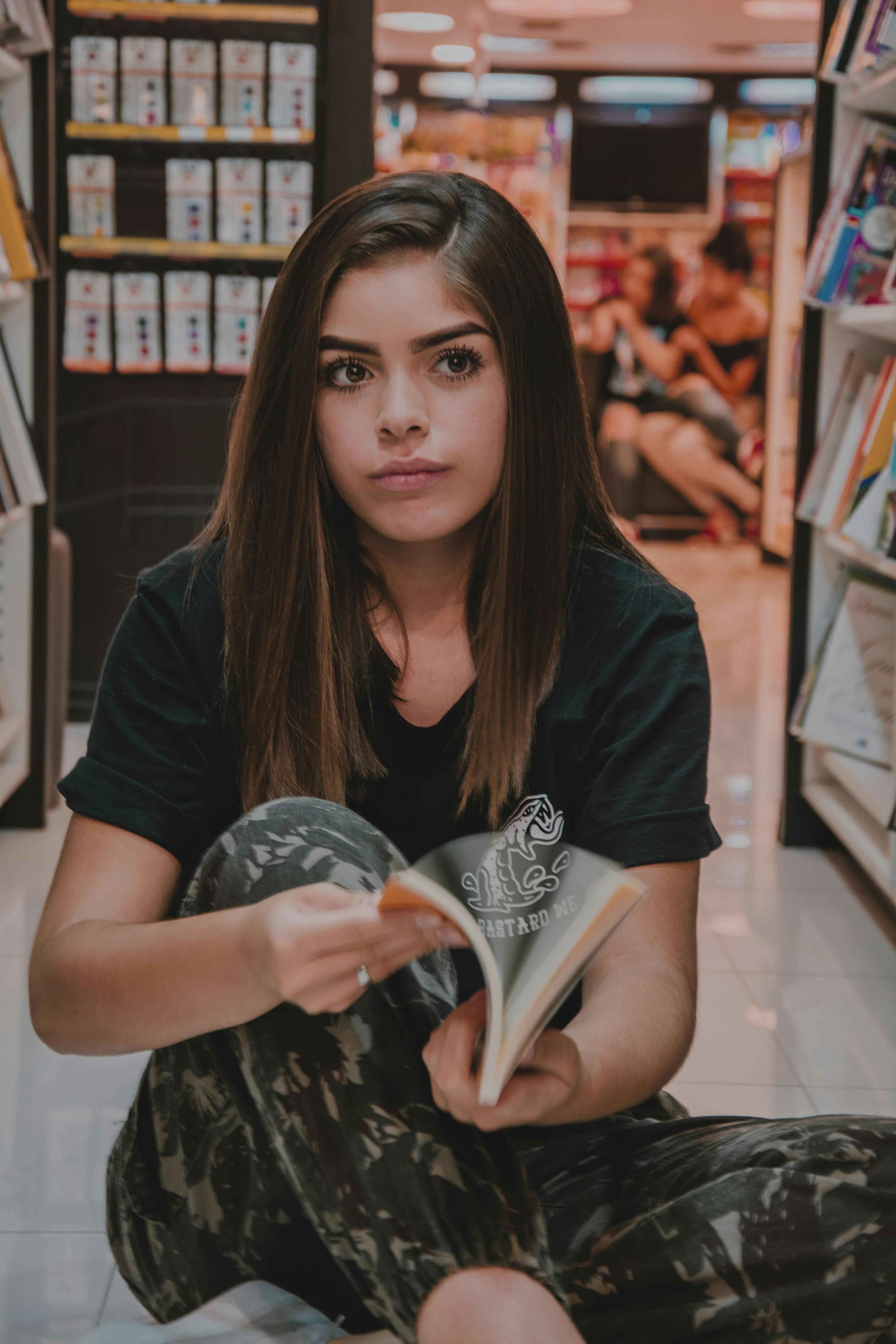 Photo of Woman Opening A Book · Free Stock Photo