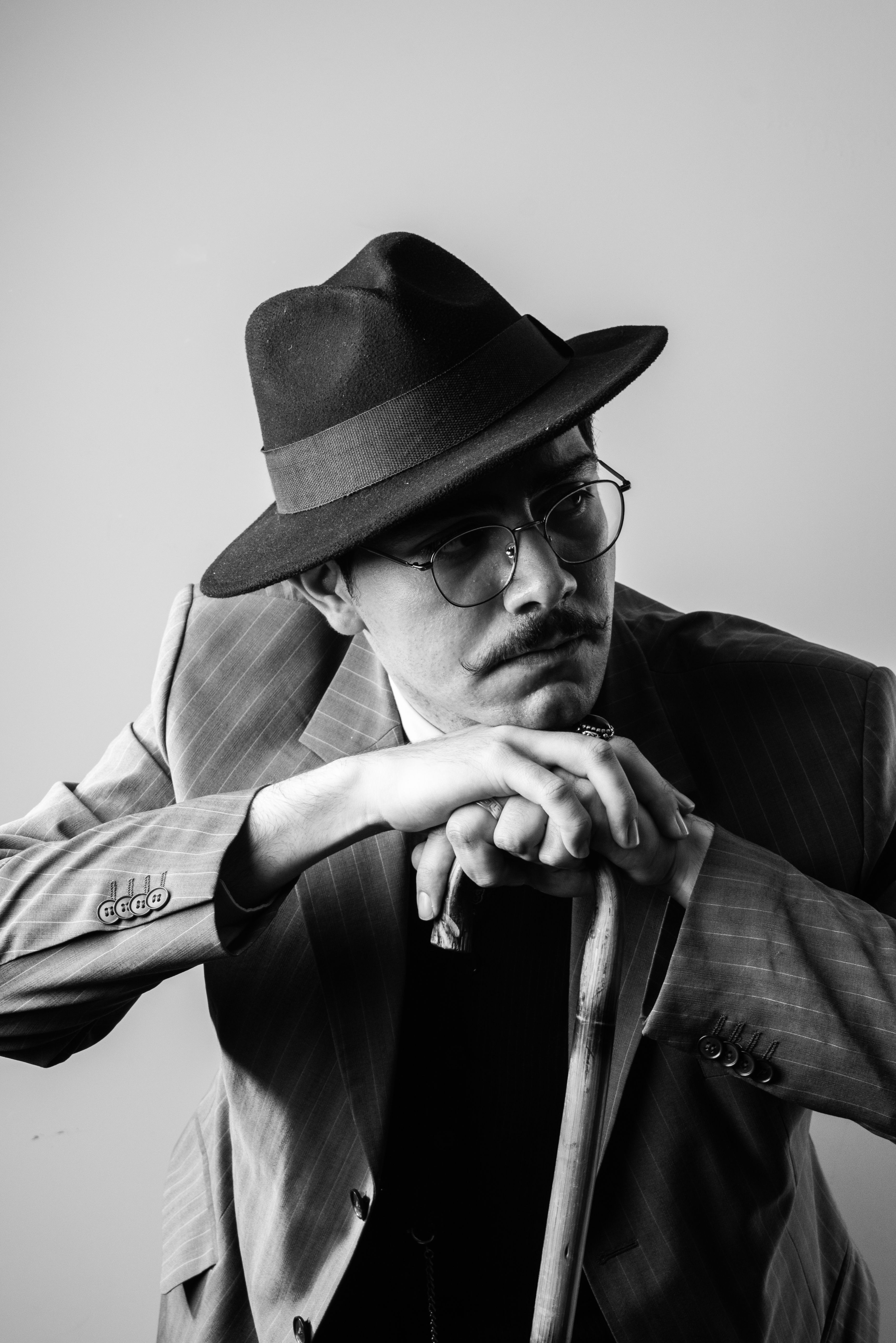 A man in a hat and suit holding a cane · Free Stock Photo