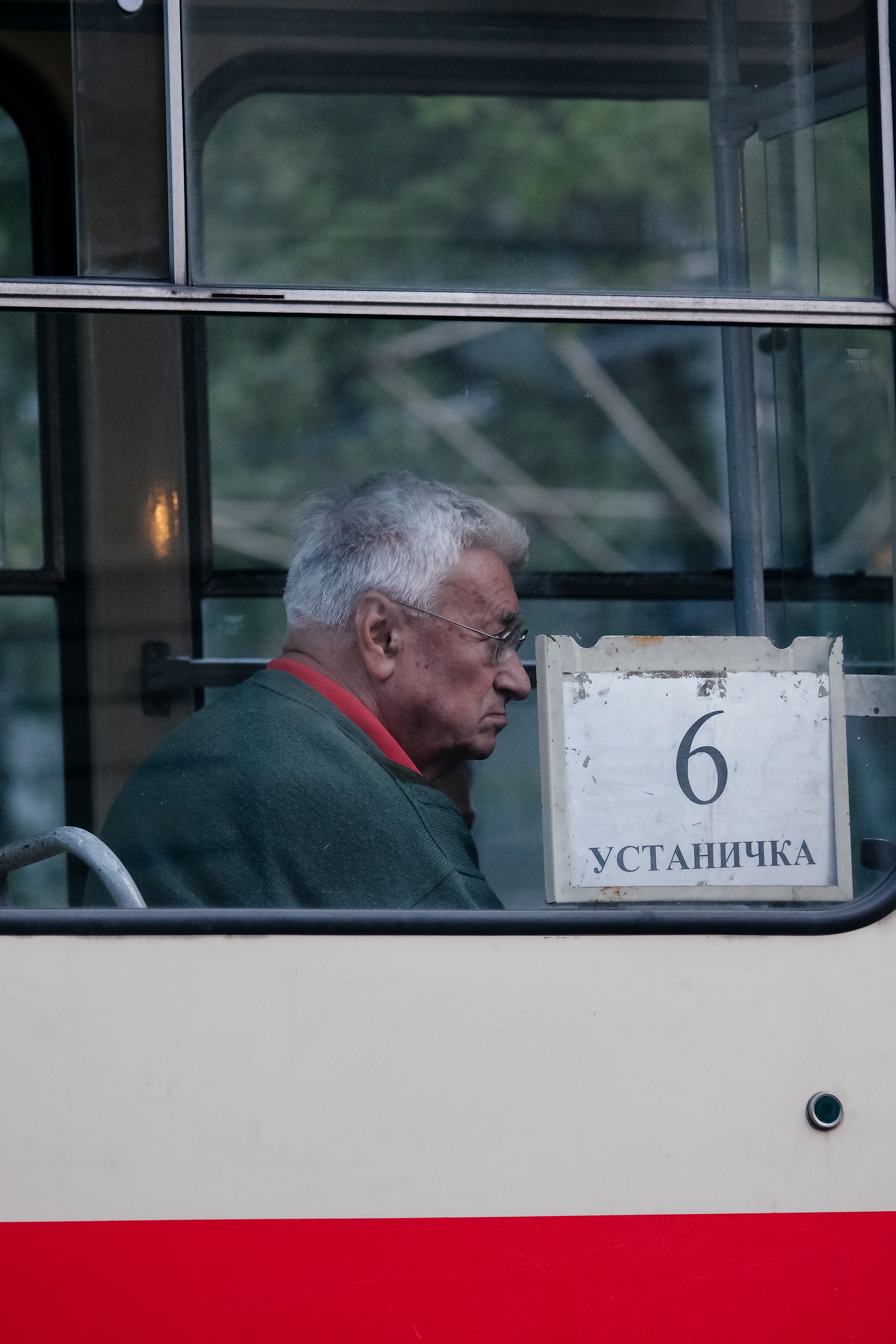 Side View of Senior Man Sitting in Bus · Free Stock Photo