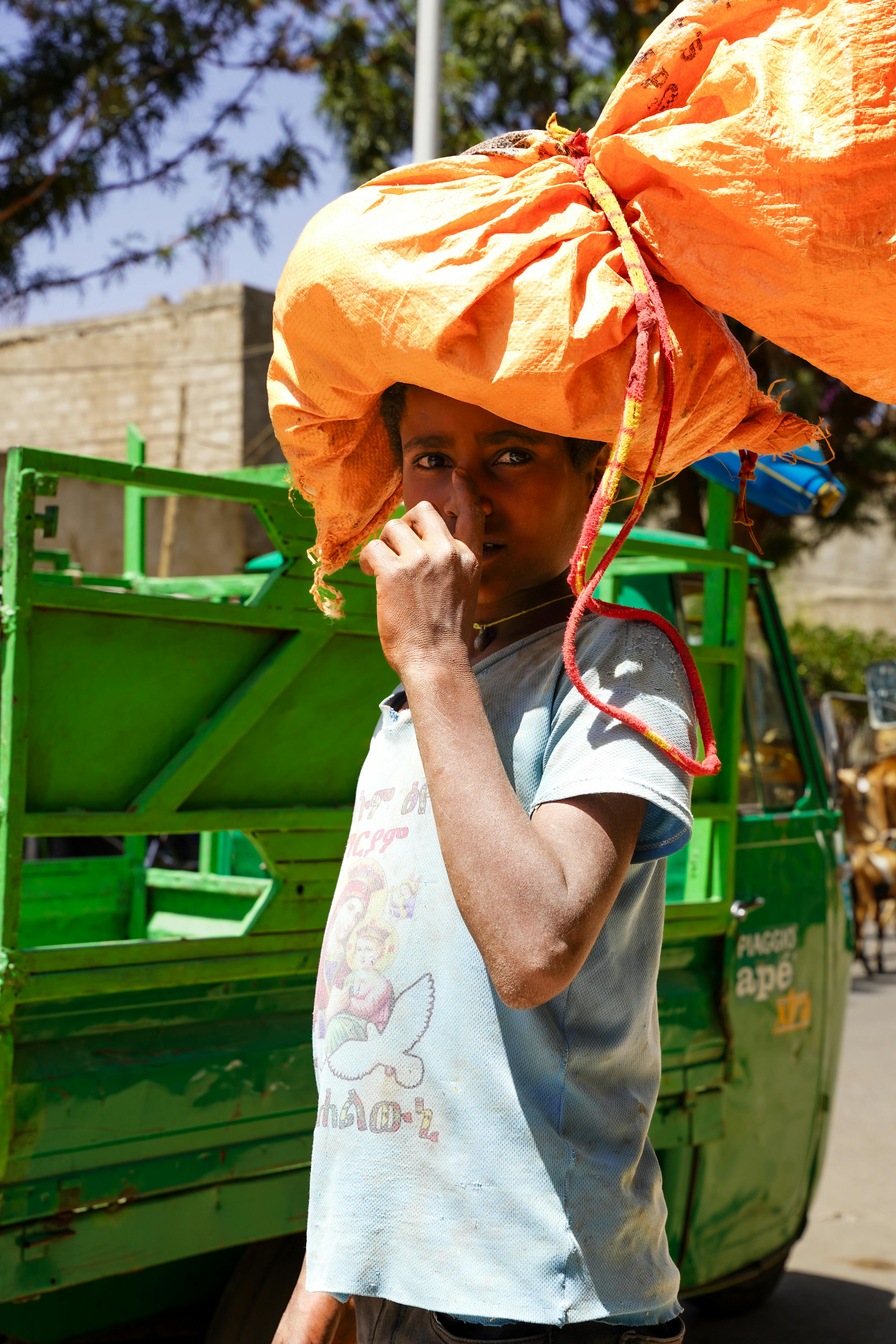 Child Carrying Bag on Head · Free Stock Photo