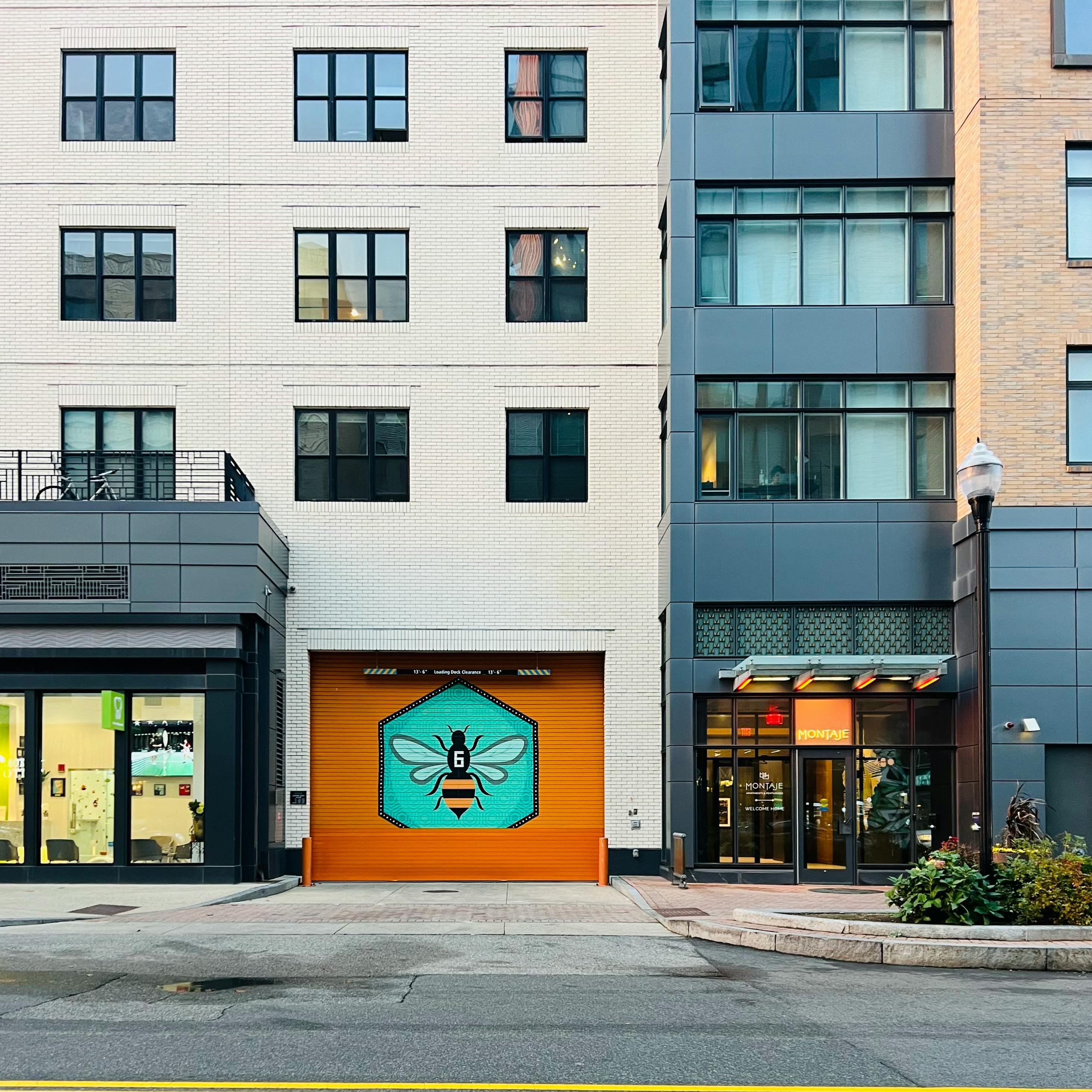 A building with a large yellow bee on it · Free Stock Photo