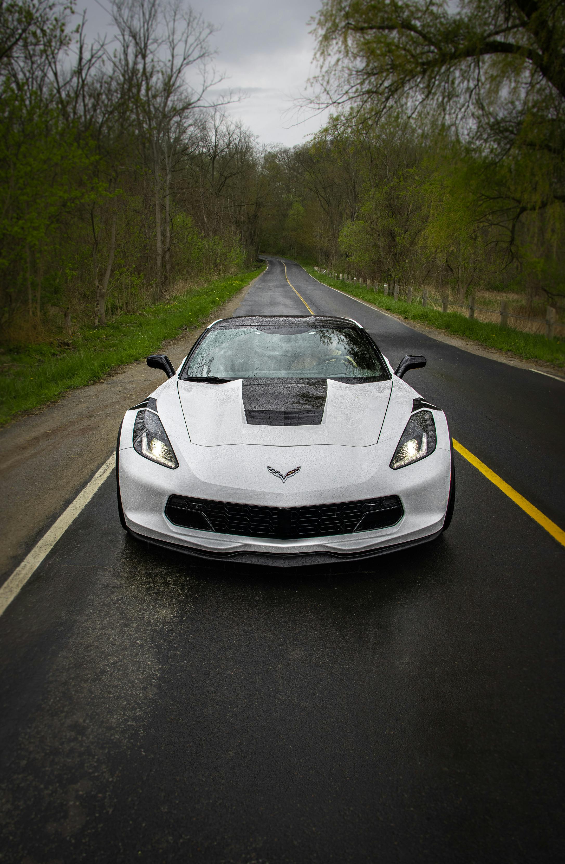 A White Chevrolet Corvette Driving on a Road · Free Stock Photo