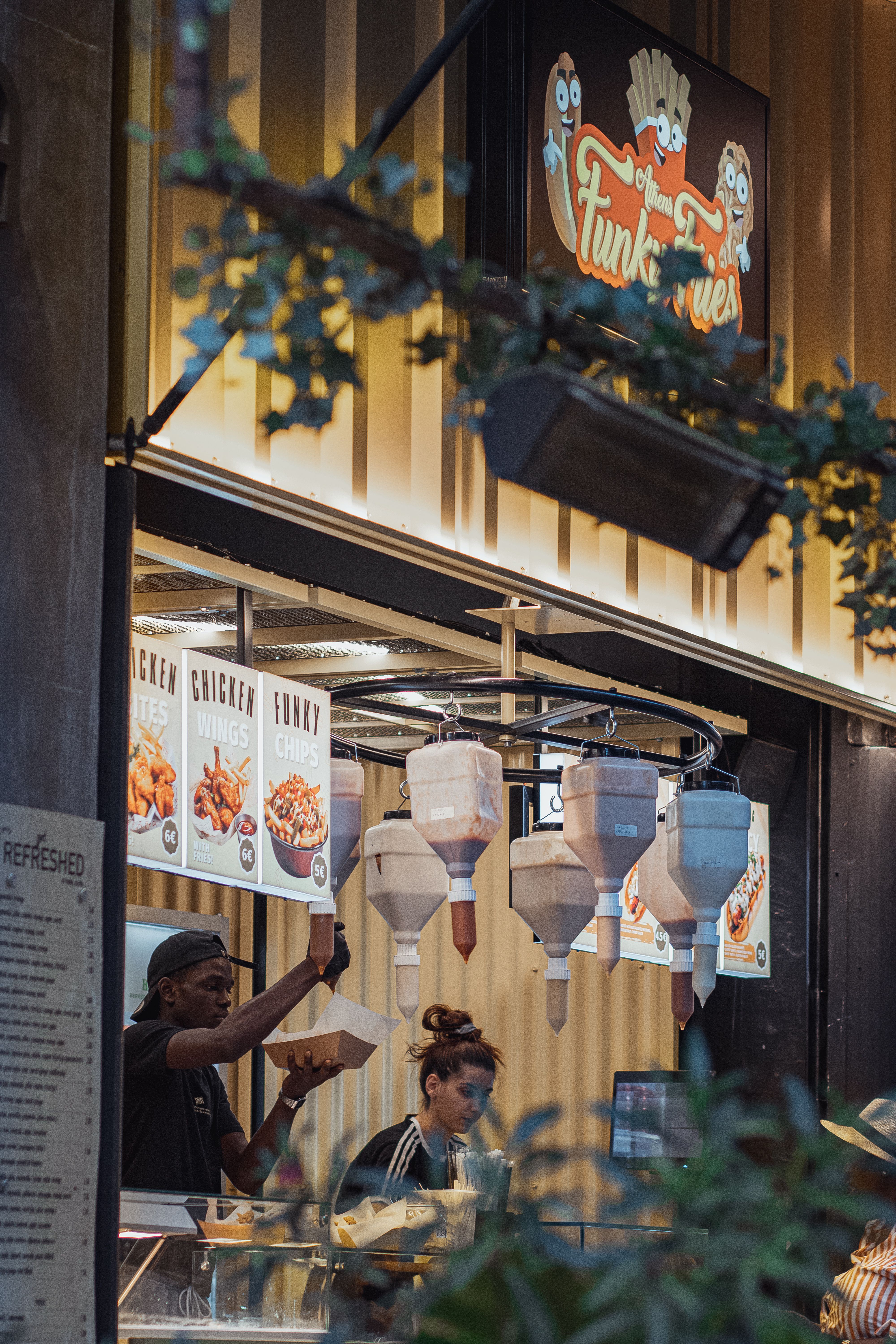 Street Food Stall next to Restaurant at Night · Free Stock Photo