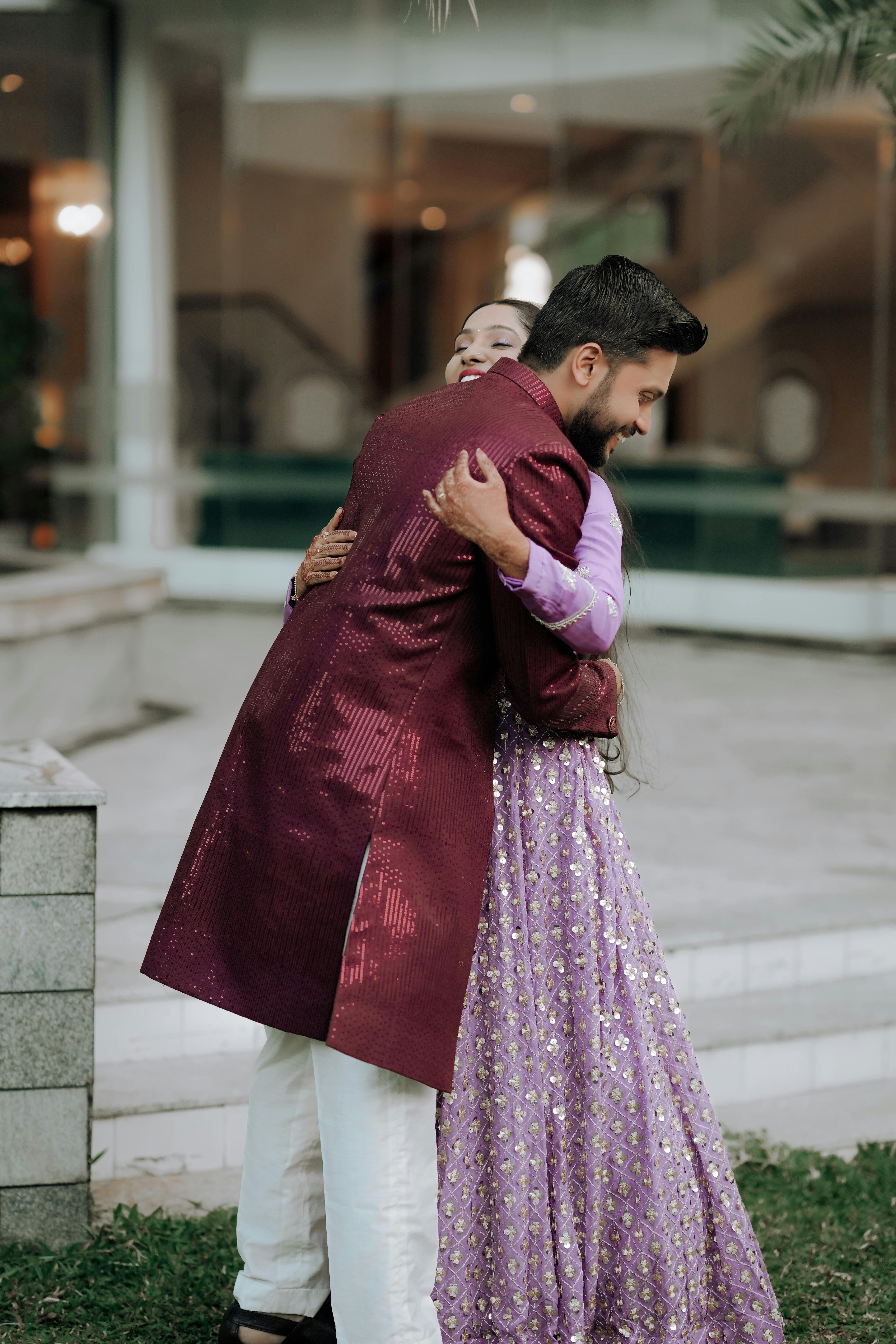 Smiling Bride And Groom in Traditional Indian Clothing Hugging Outdoors ...