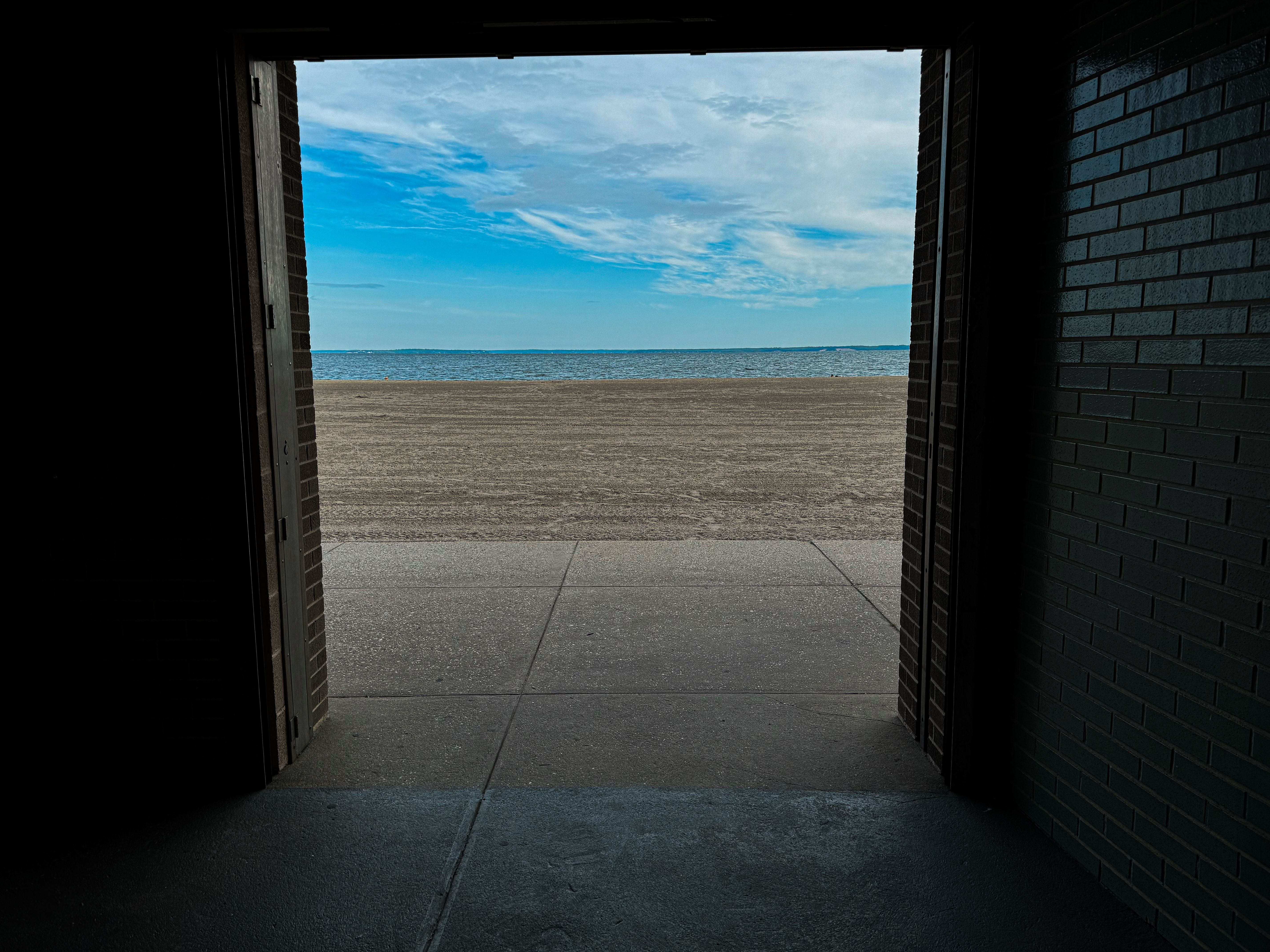 View of the Beach and Sea through the Open Door of a Building · Free ...