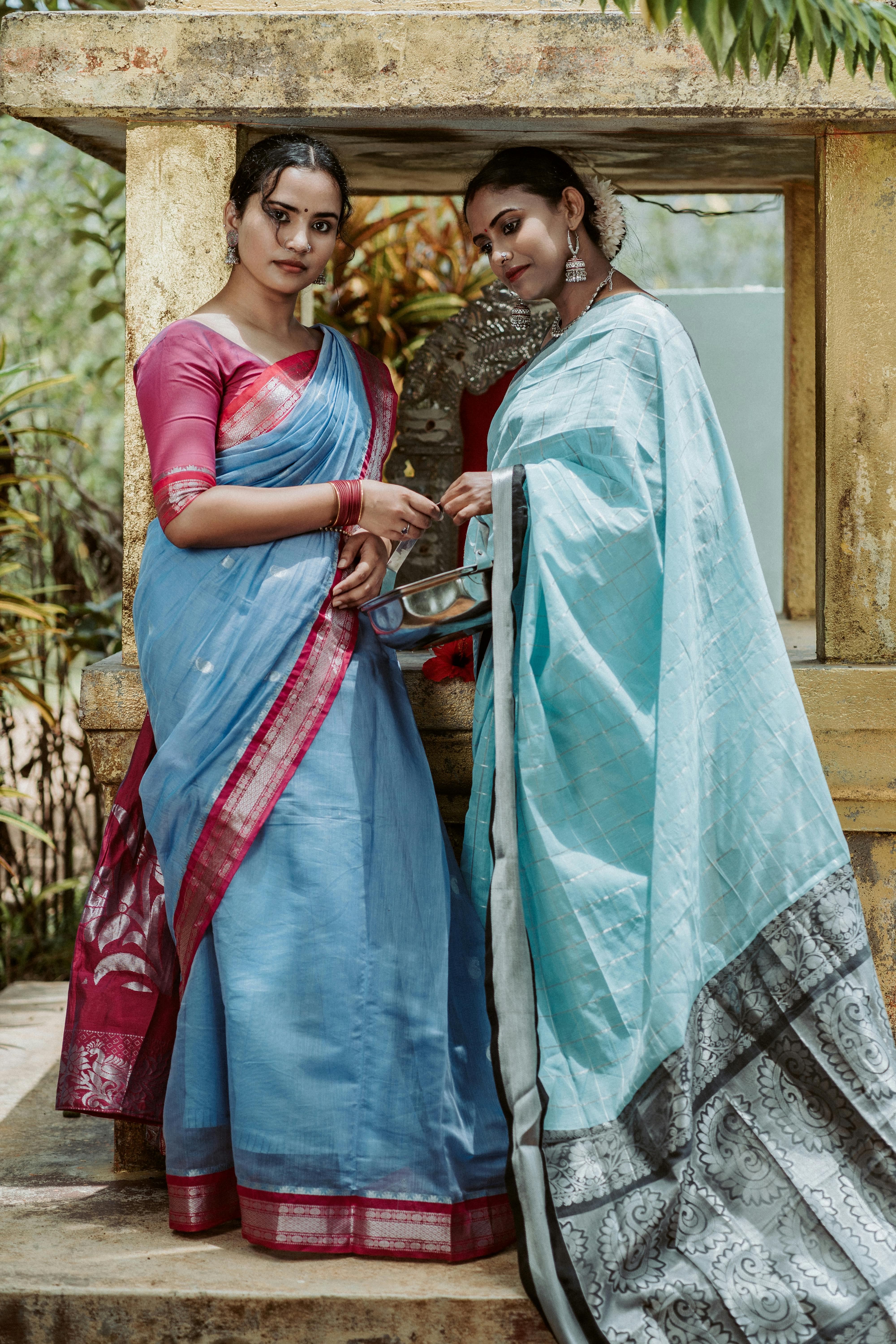 Two young women dressed in traditional South Indian sarees · Free Stock ...