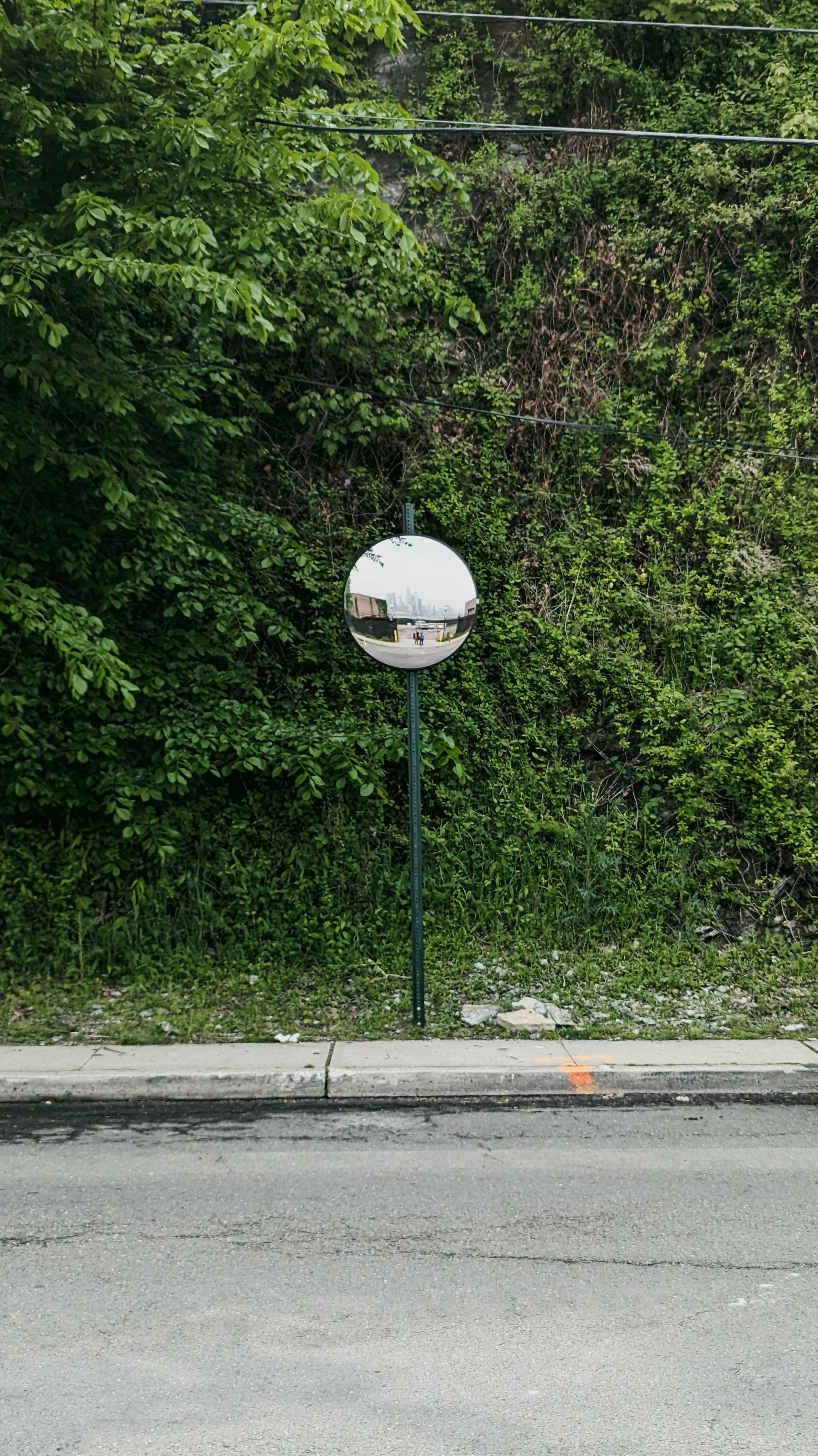 Round Mirror Traffic Sign on Side of Road · Free Stock Photo
