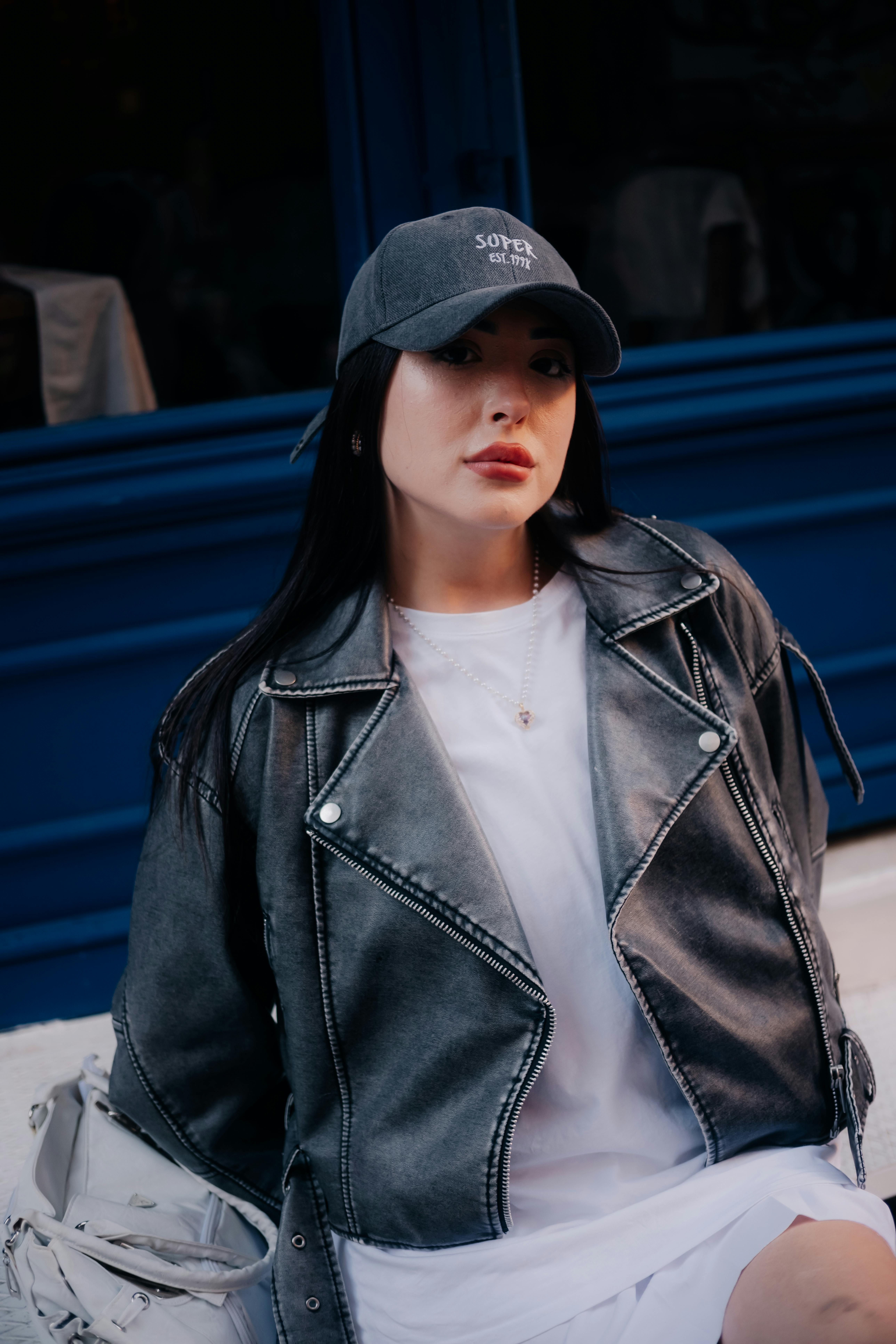 Woman in Black Leather Jacket and Baseball Cap · Free Stock Photo