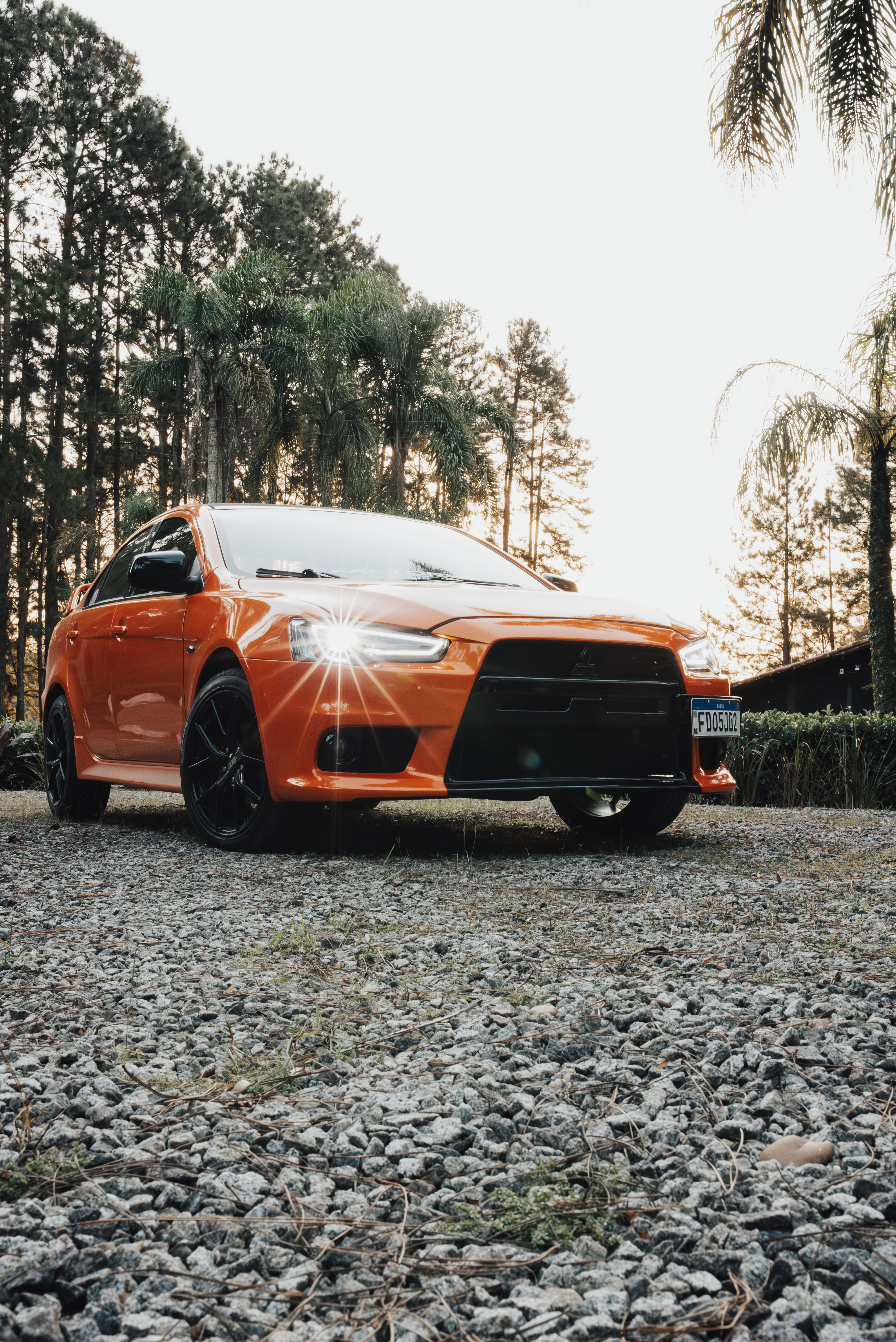 Front of an Orange Mitsubishi Lancer with its Headlights On · Free ...