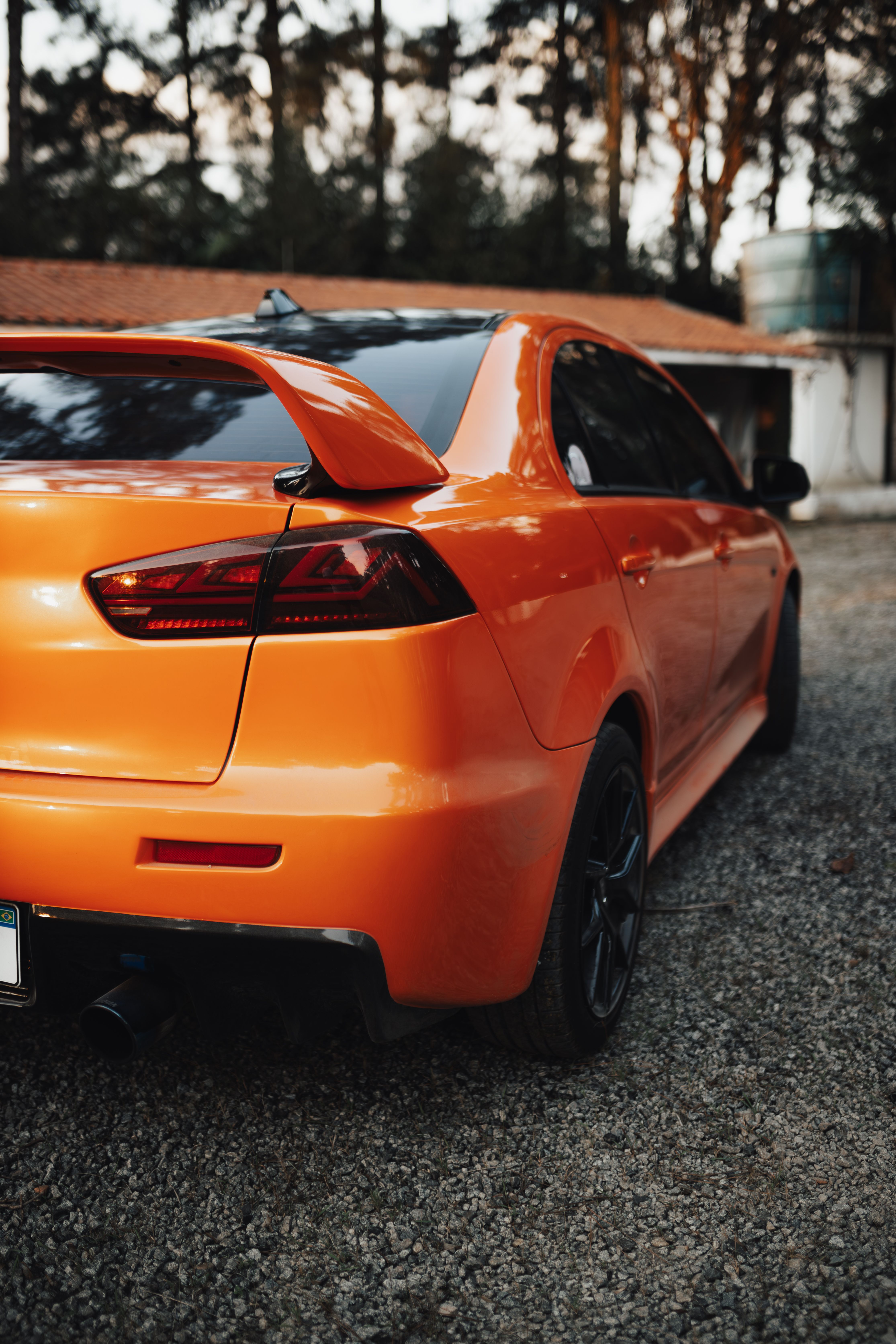Rear and Side of Orange Mitsubishi Lancer Evolution X · Free Stock Photo