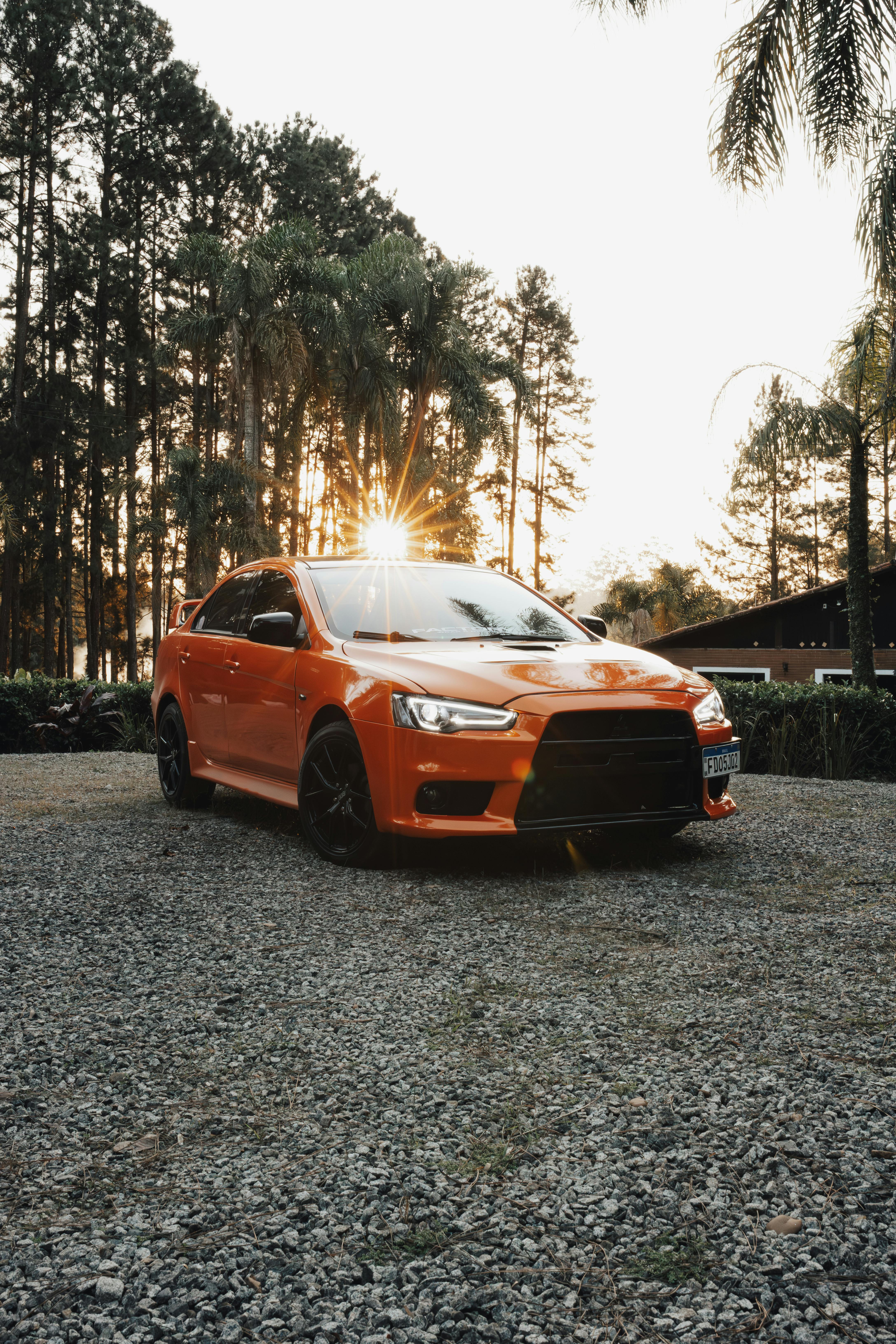 Orange Mitsubishi Lancer Evolution X at Sunset · Free Stock Photo