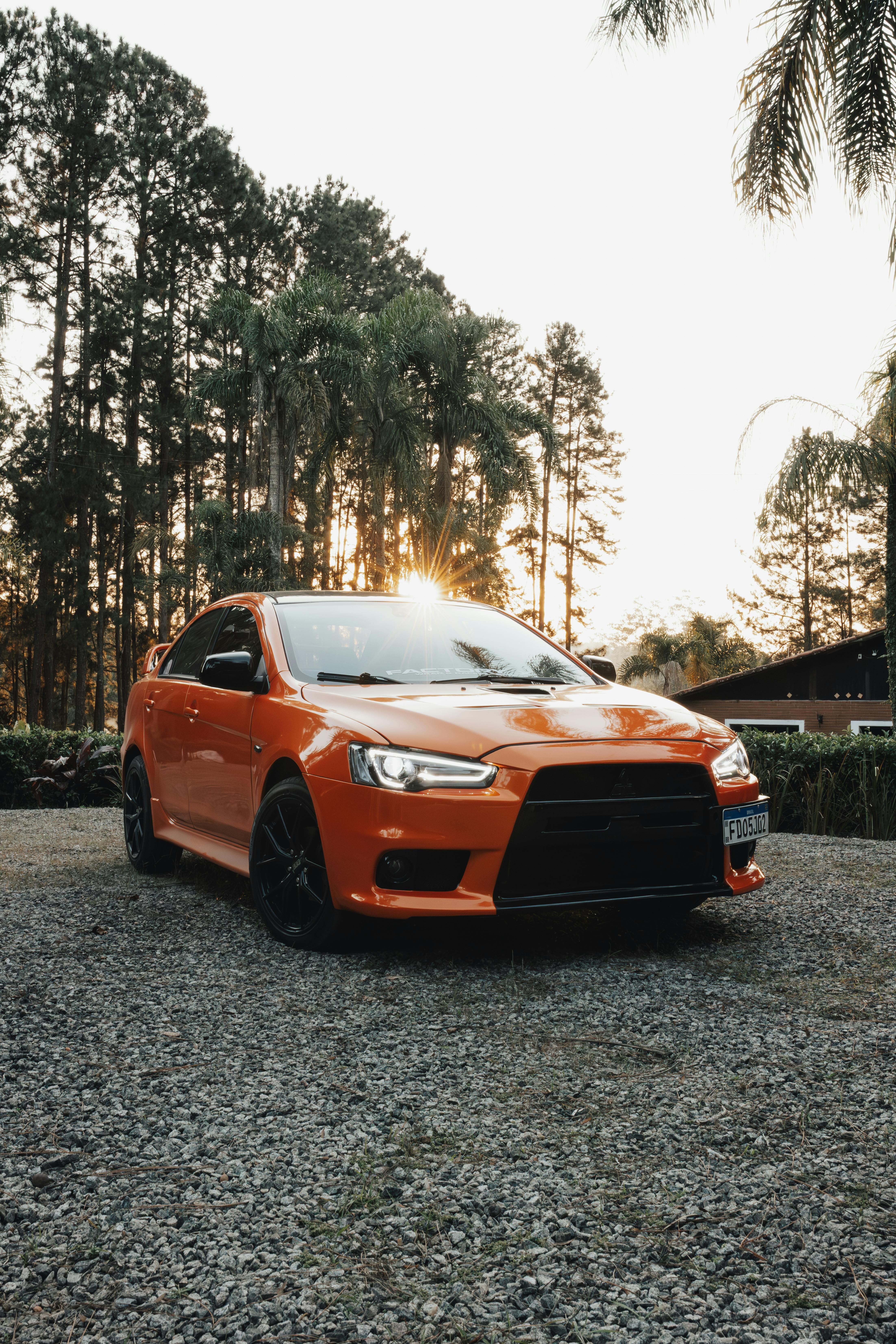 Sun Setting Over Orange Mitsubishi Lancer · Free Stock Photo