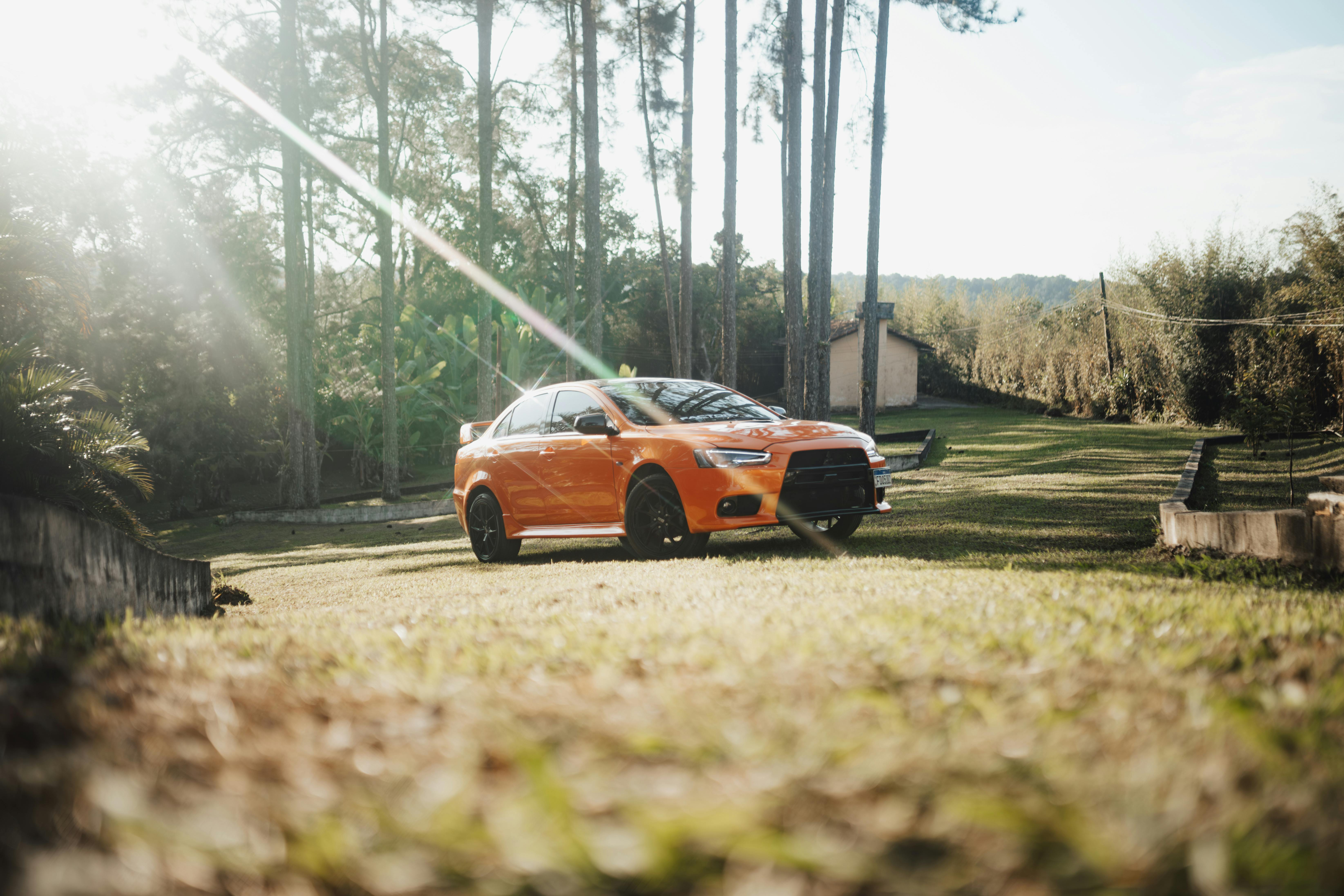 Orange Mitsubishi Lancer Evolution in Forest · Free Stock Photo