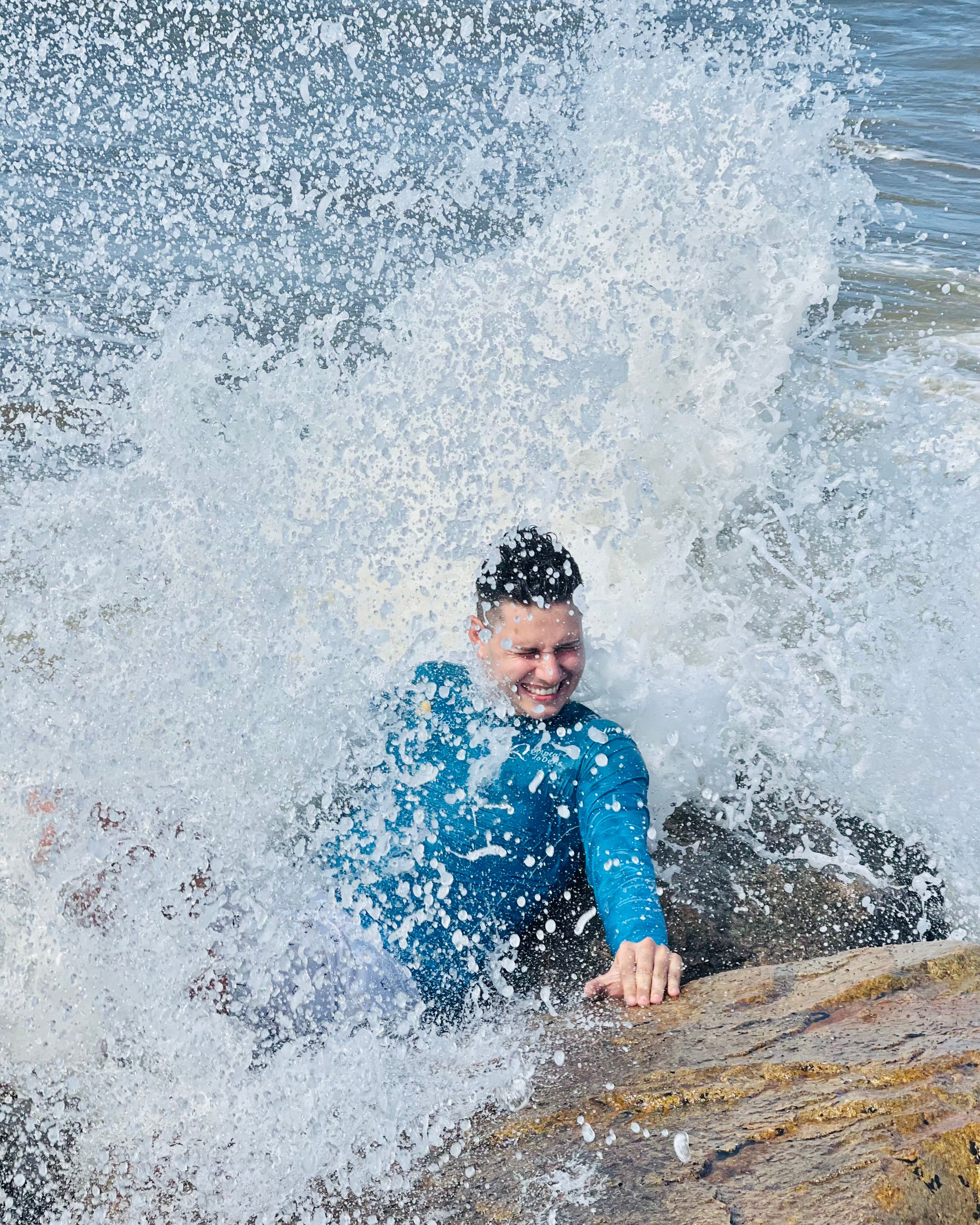 Man on Rock Washed by Wave · Free Stock Photo