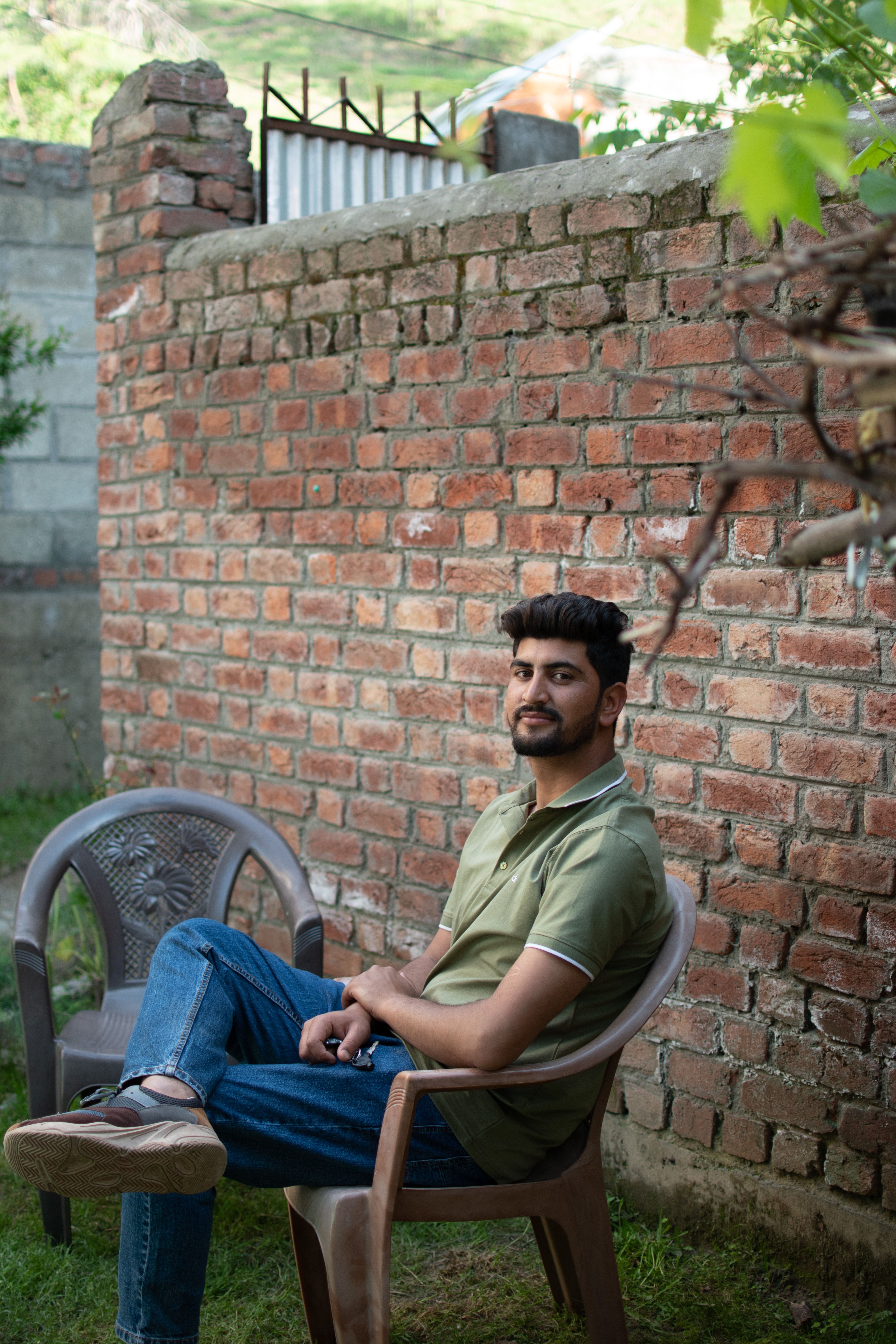 Serene Man Sitting in Yard · Free Stock Photo