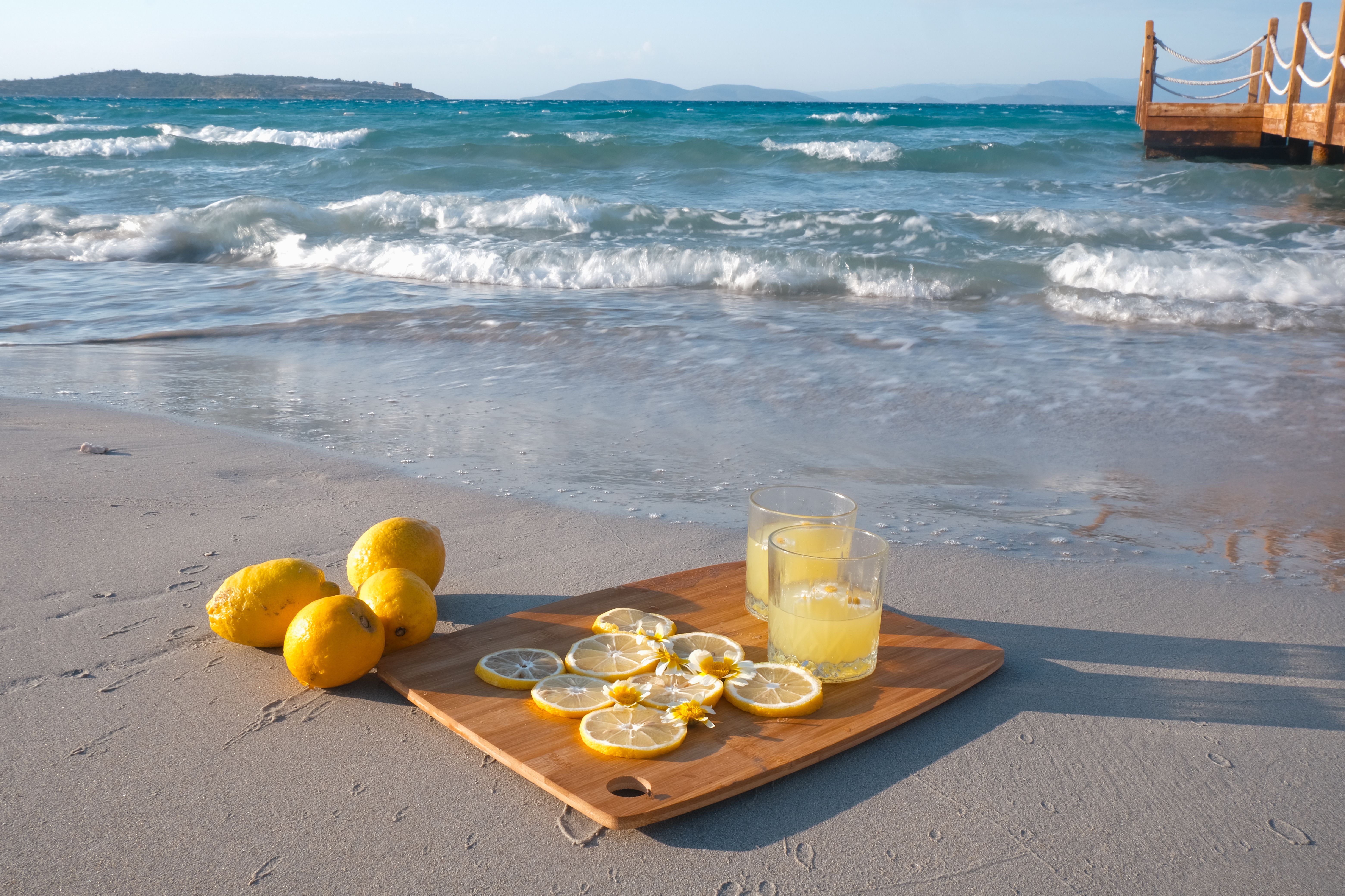 Lemonade, Lemons and Lemon Slices on a Cutting Board Lying on a Beach ...