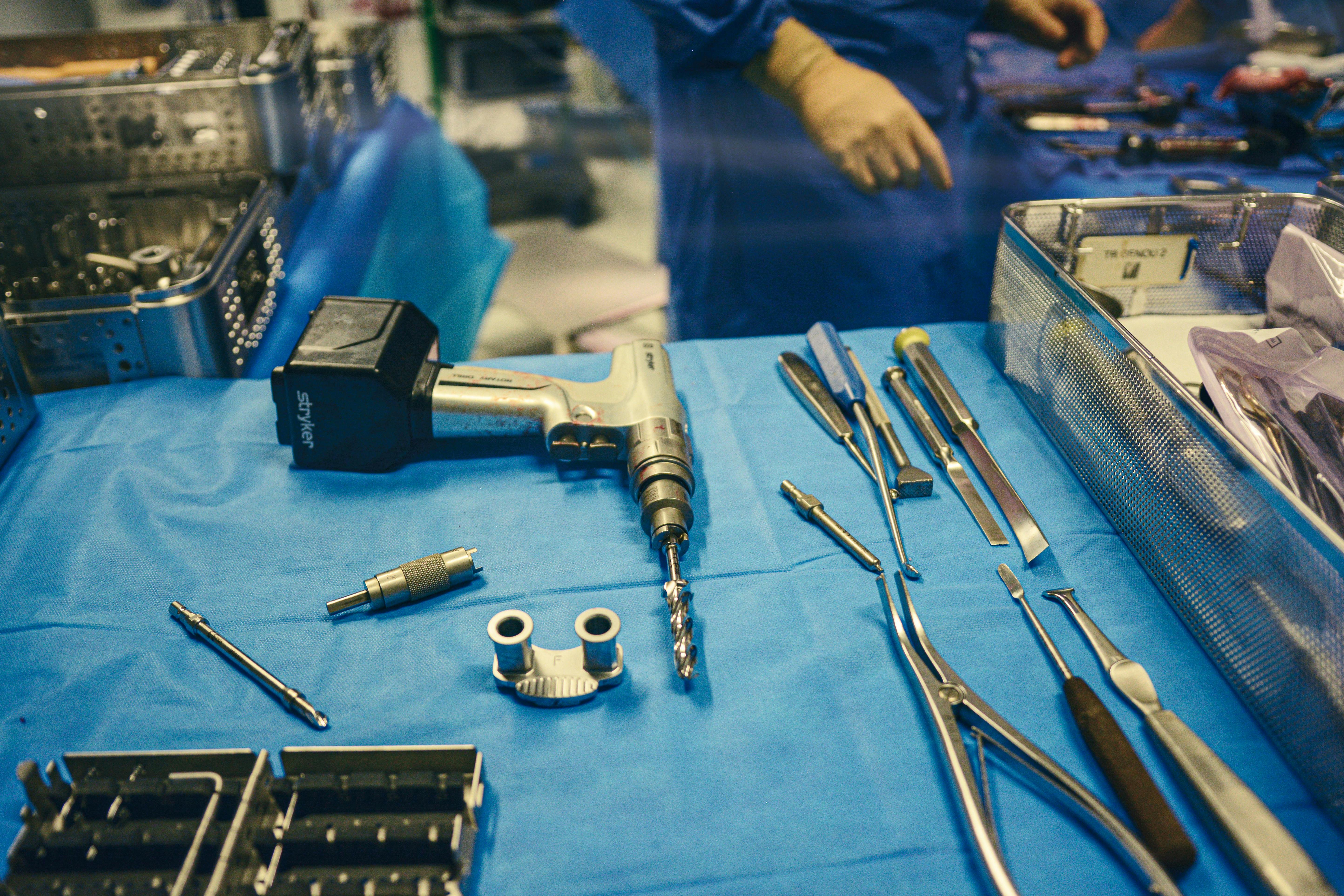 A Woman Arranging Medical Tools in an Operating Room · Free Stock Photo